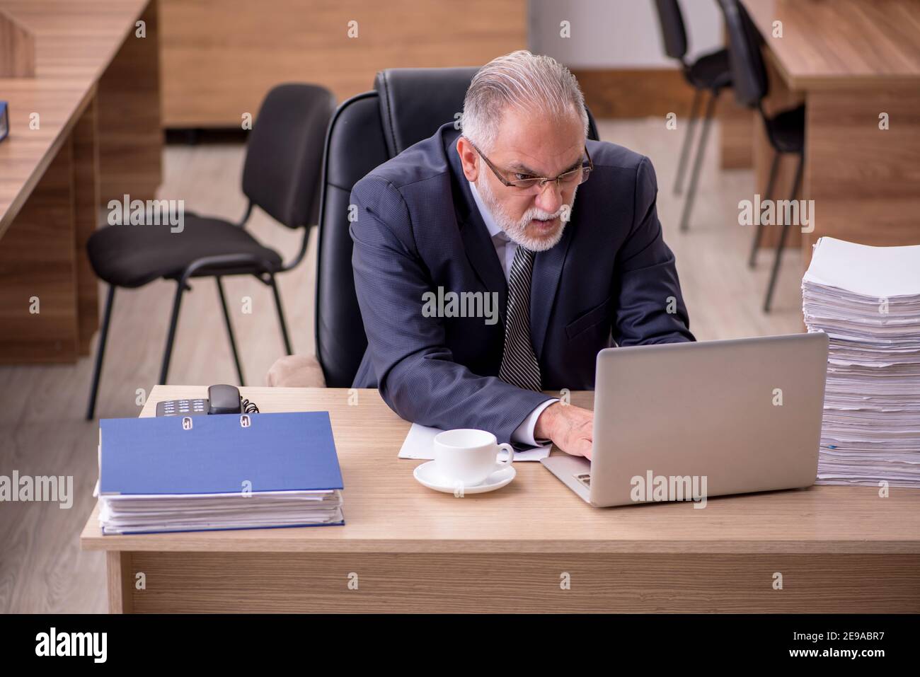 Old employee working in the office Stock Photo - Alamy