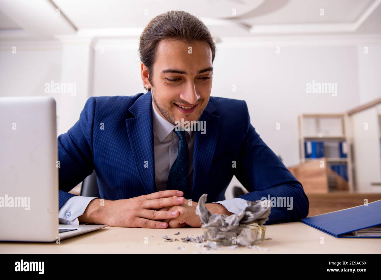 Young man employee burning papers in the office Stock Photo - Alamy