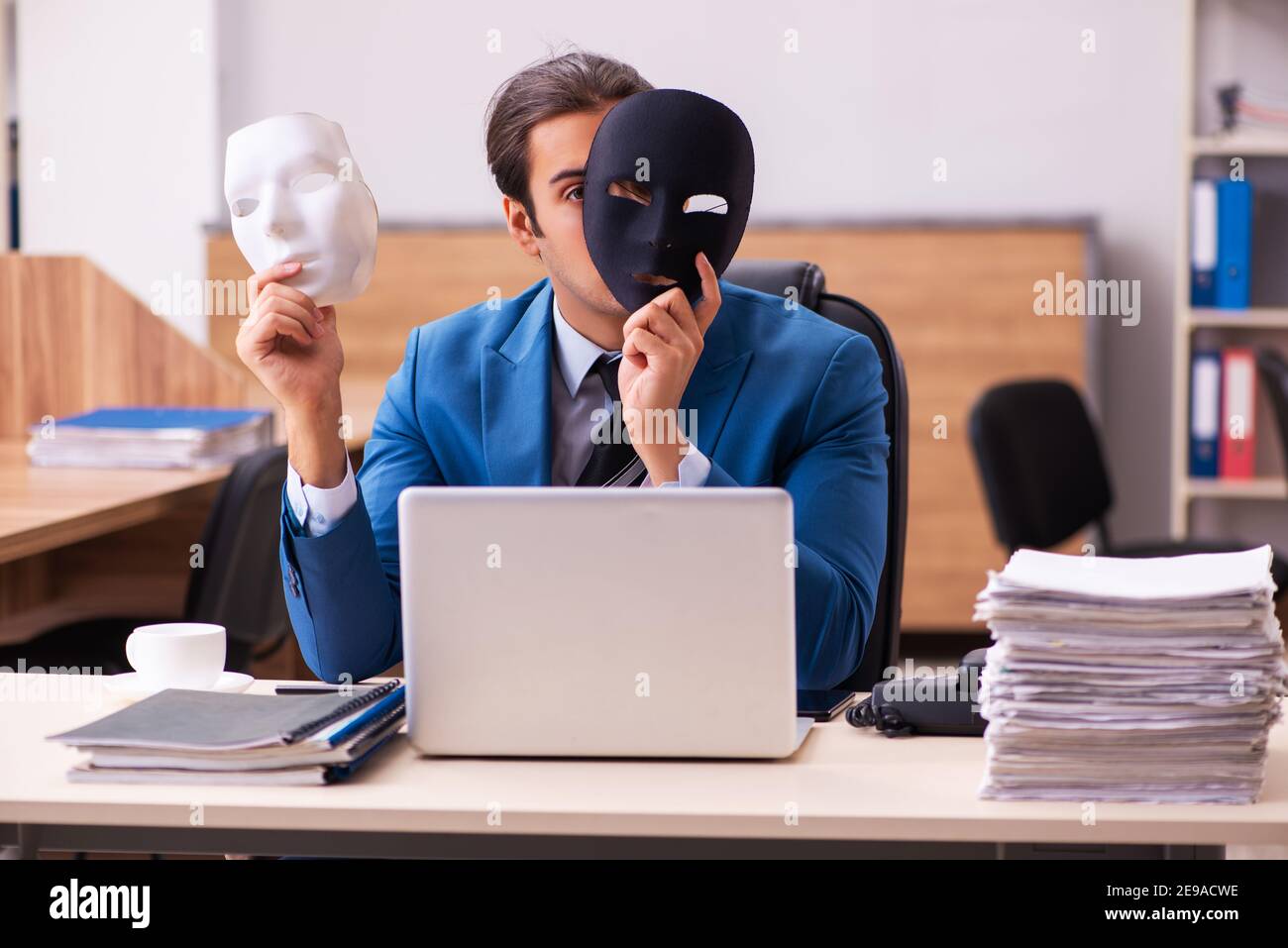 Young employee wearing masks in the office Stock Photo - Alamy
