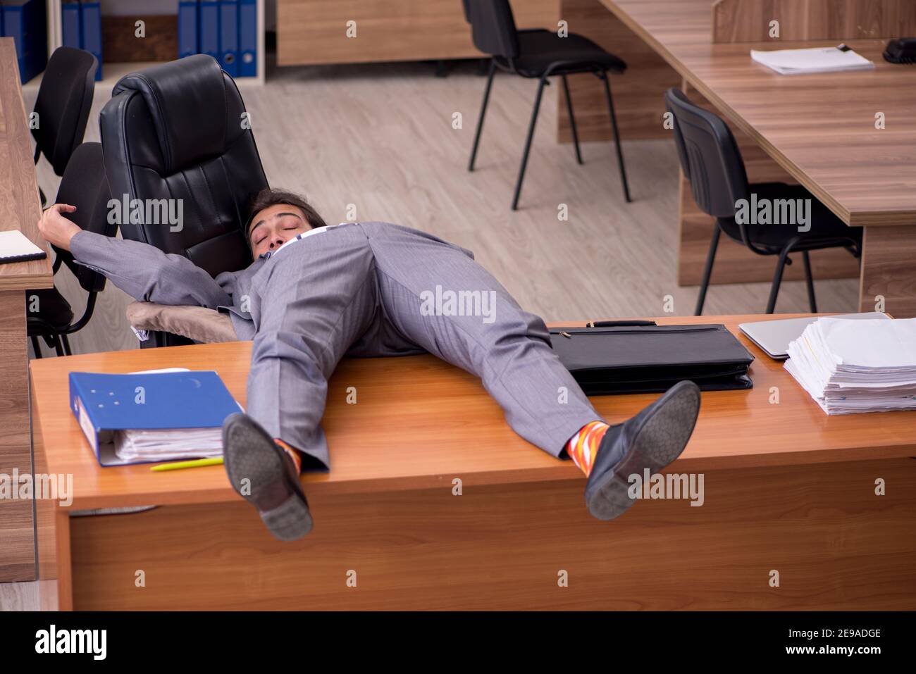 Young employee sleeping at workplace Stock Photo - Alamy