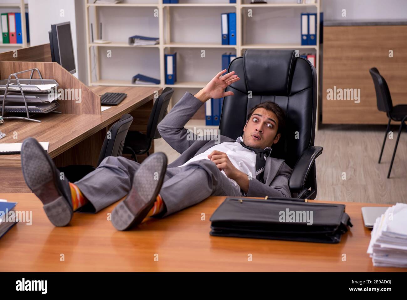 Young employee sleeping at workplace Stock Photo - Alamy