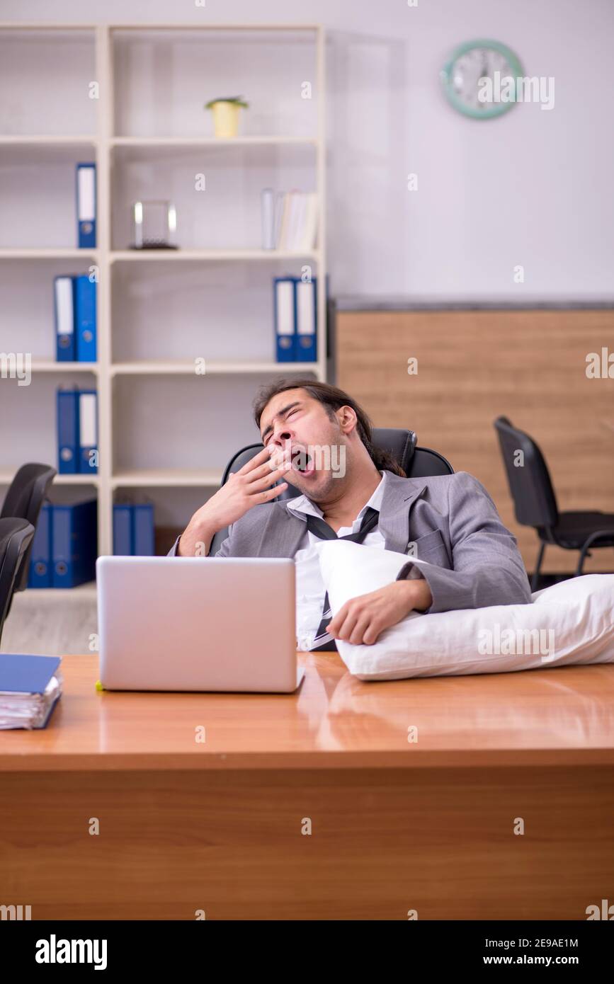 Young employee sleeping at workplace Stock Photo - Alamy