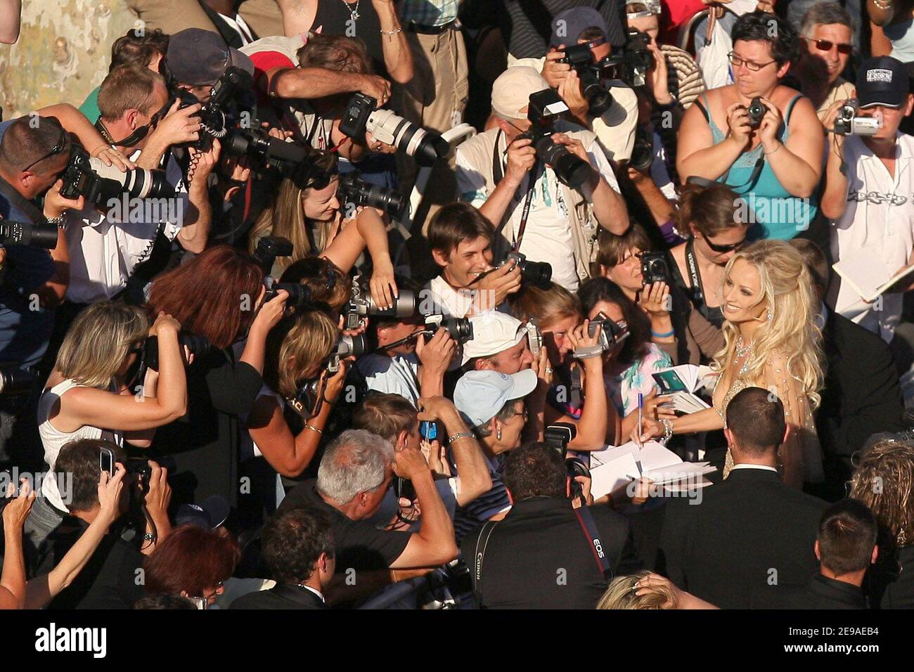 Slovak supermodel Adriana Karembeu signs autographs to fans in front of ...