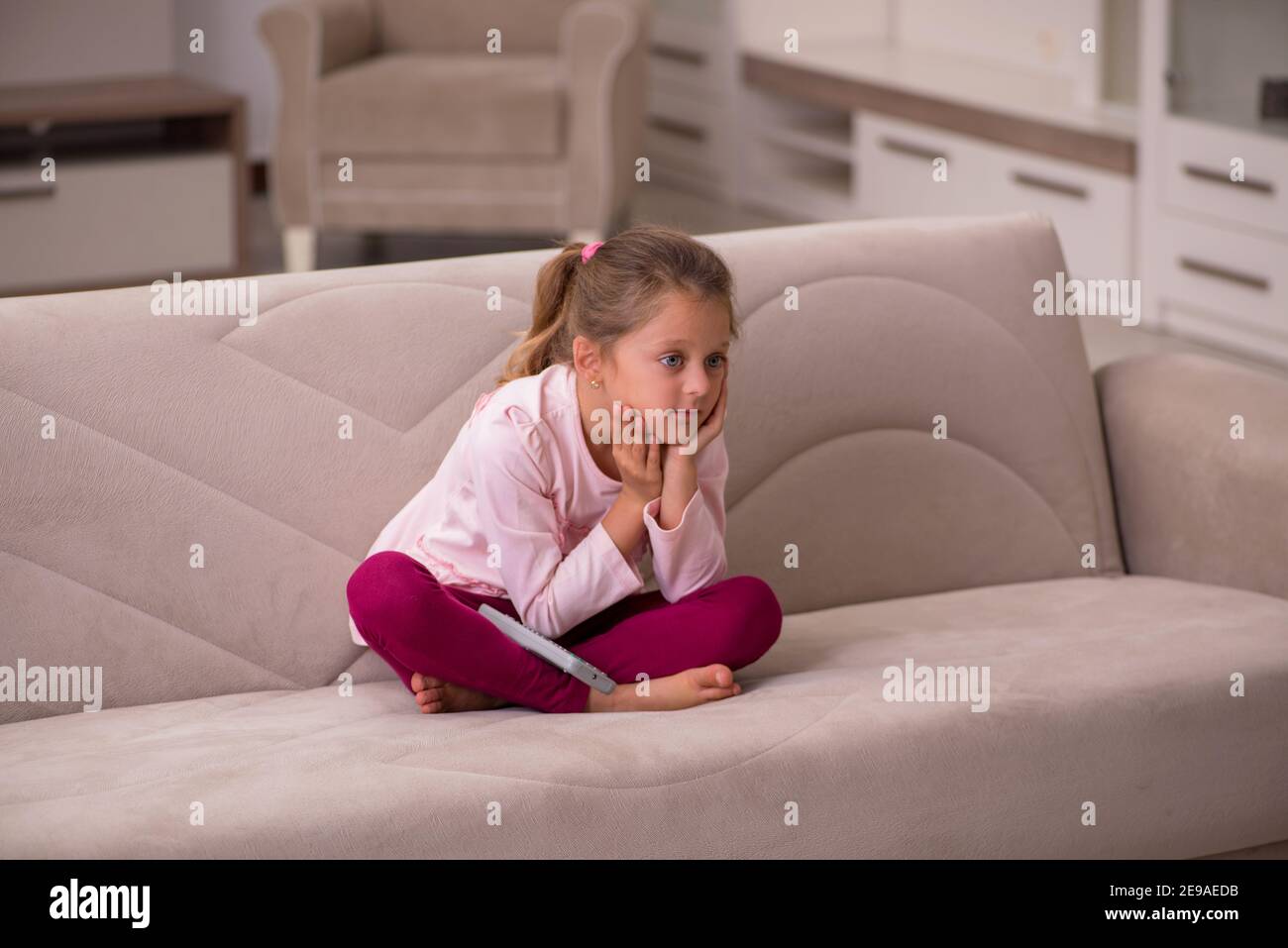 Little girl staying alone at home Stock Photo - Alamy