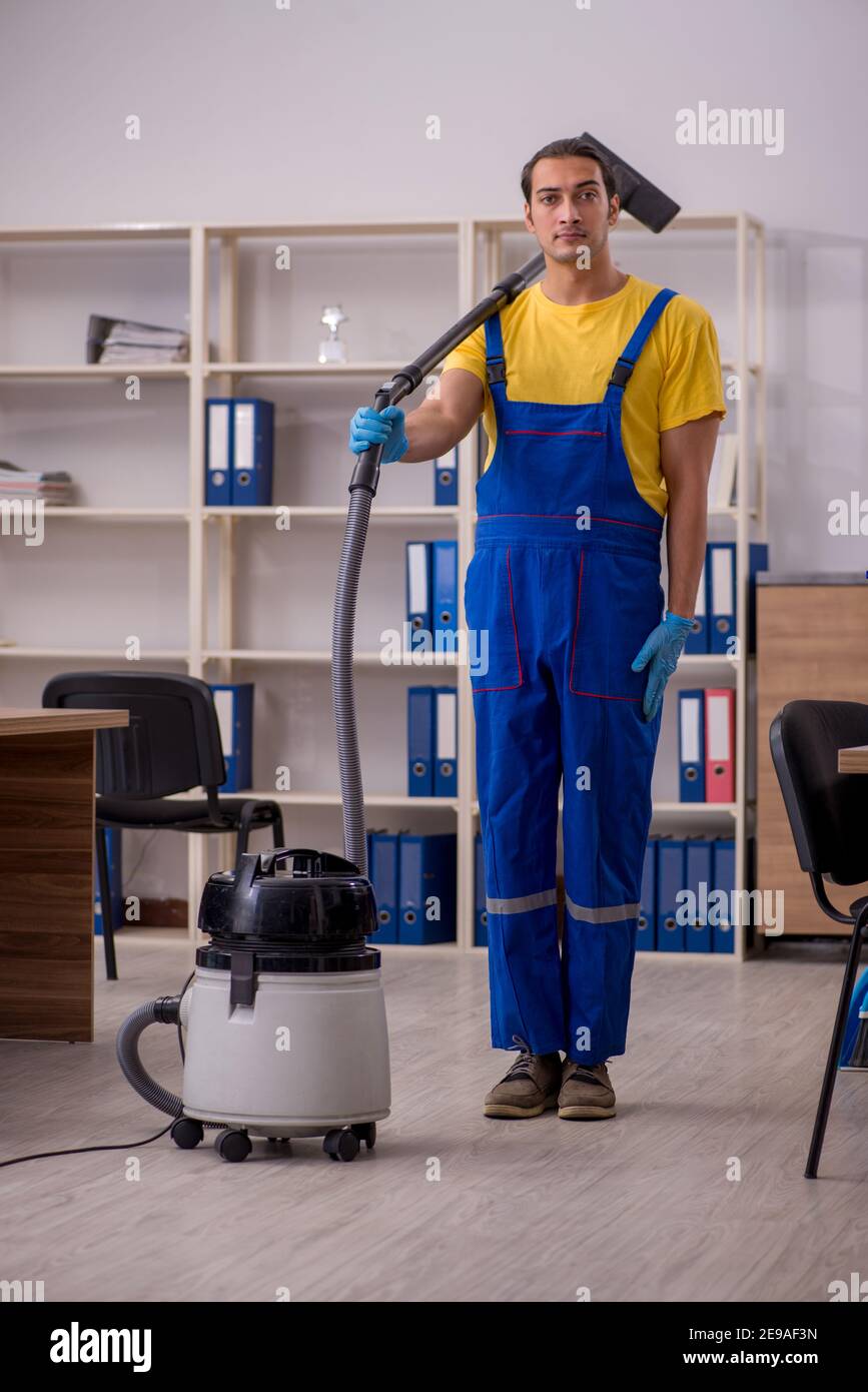 Male contractor cleaning the office Stock Photo - Alamy