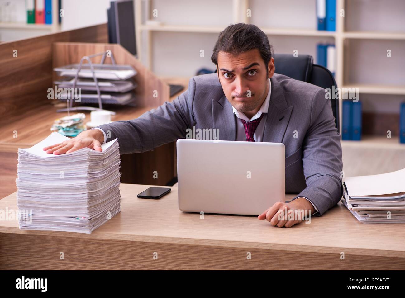 Young employee extremely tired with excessive work Stock Photo - Alamy