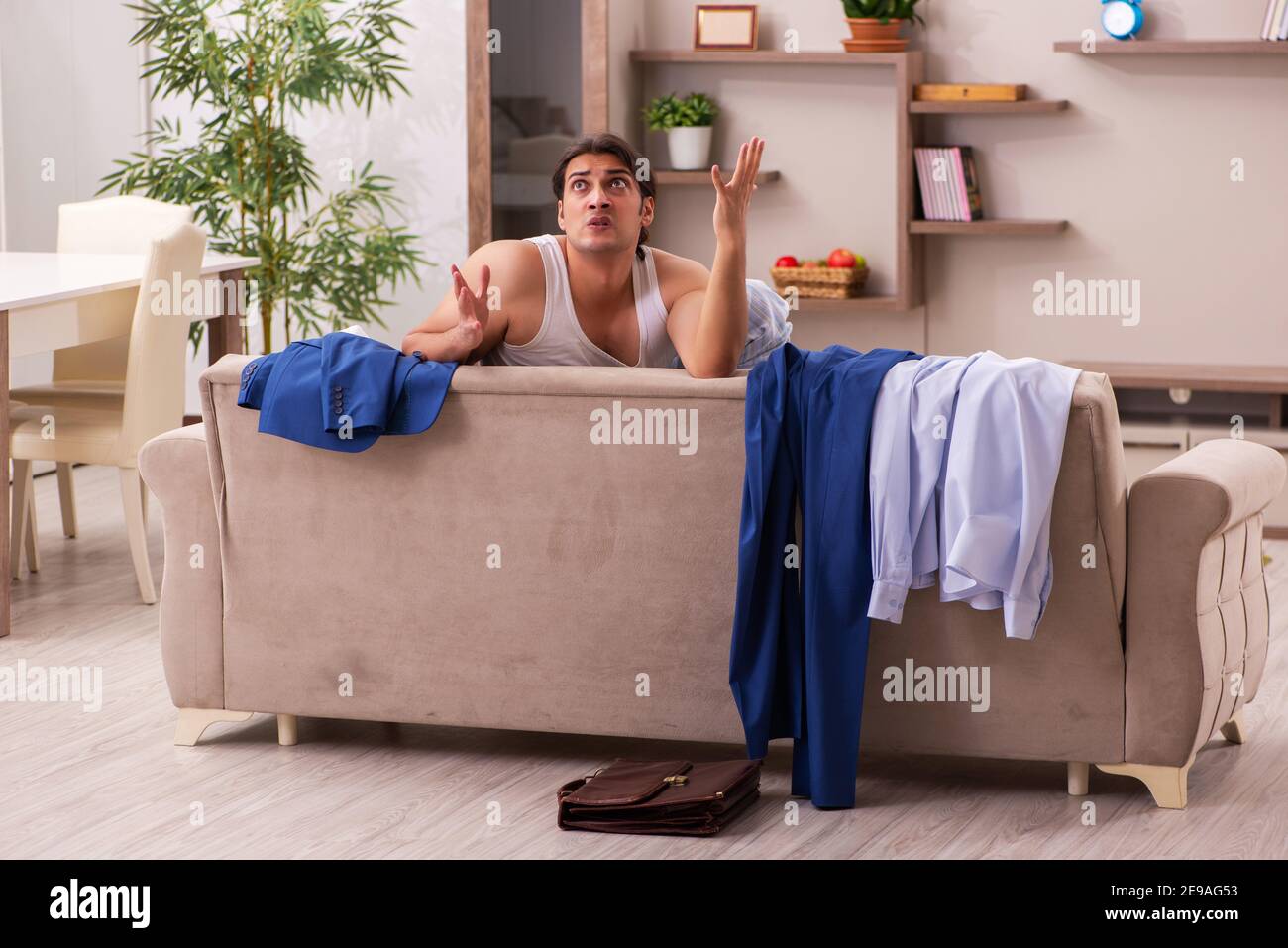 Young employee getting up late at home Stock Photo - Alamy
