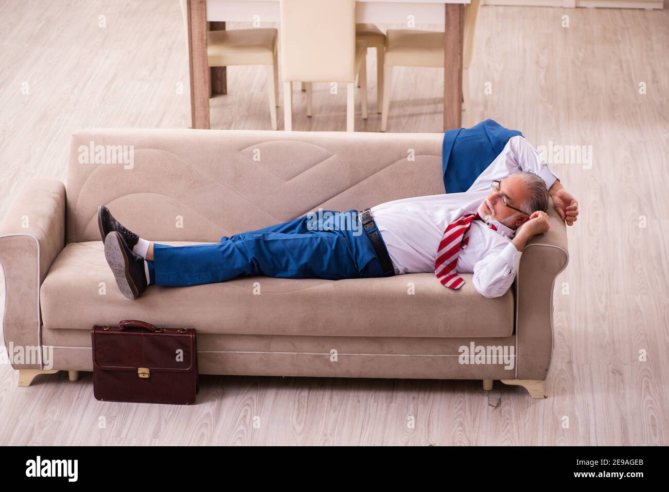 Senior male boss employee coming home from work Stock Photo - Alamy