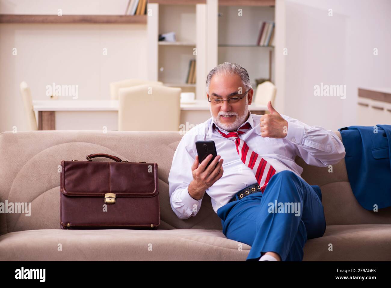 Senior male boss employee coming home from work Stock Photo - Alamy