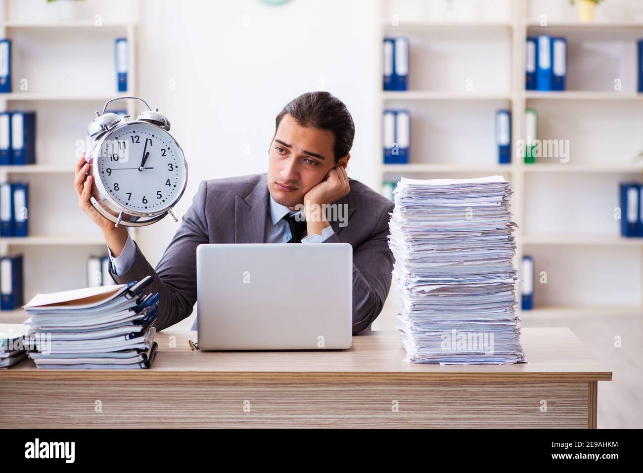 Workload employee in time management concept Stock Photo - Alamy