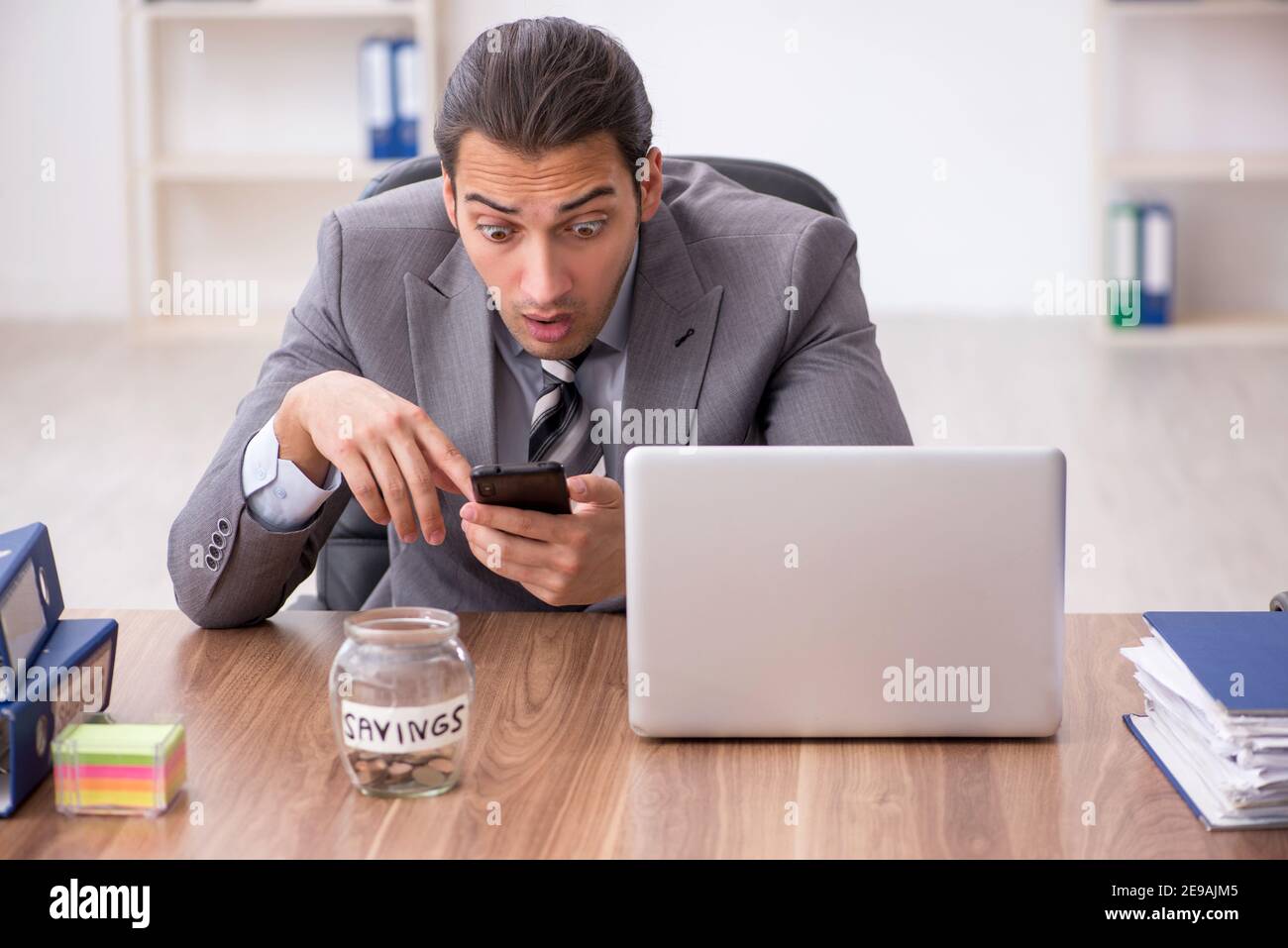 Young employee in pension concept at workplace Stock Photo - Alamy