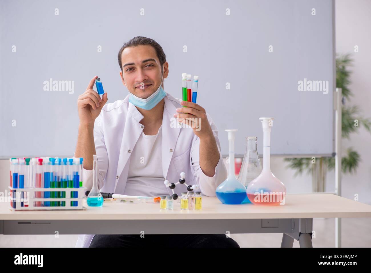 Young chemist working in the lab Stock Photo - Alamy