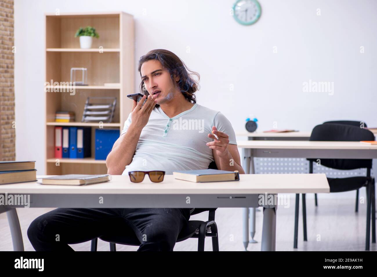 Male student smoking cigarettes in the classroom Stock Photo - Alamy