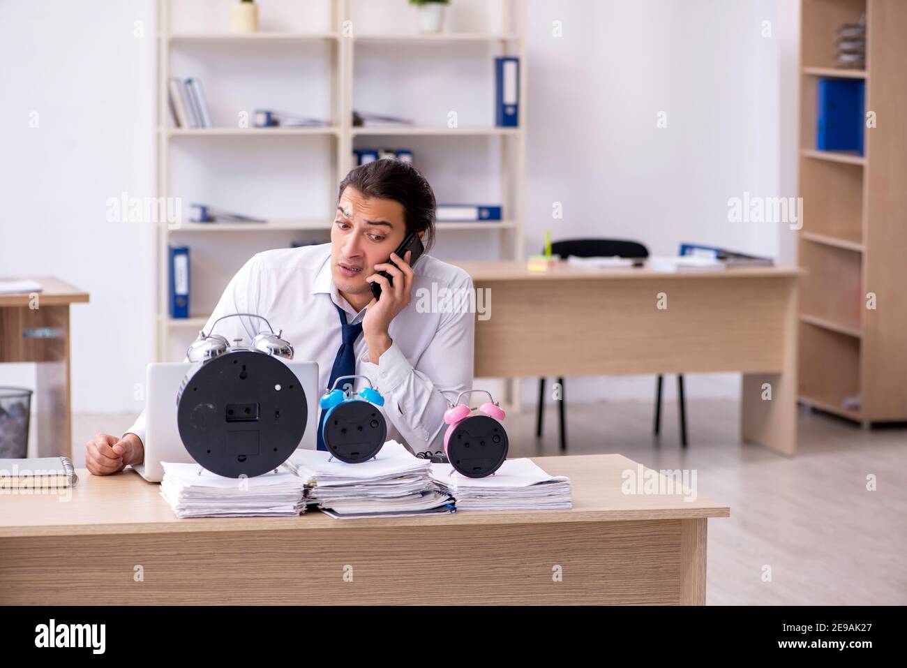 Young employee afraid of missing deadline at workplace Stock Photo - Alamy