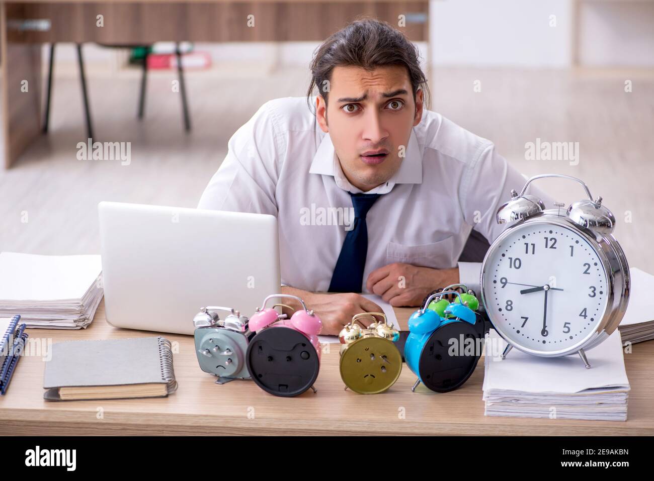 Young employee afraid of missing deadline at workplace Stock Photo - Alamy