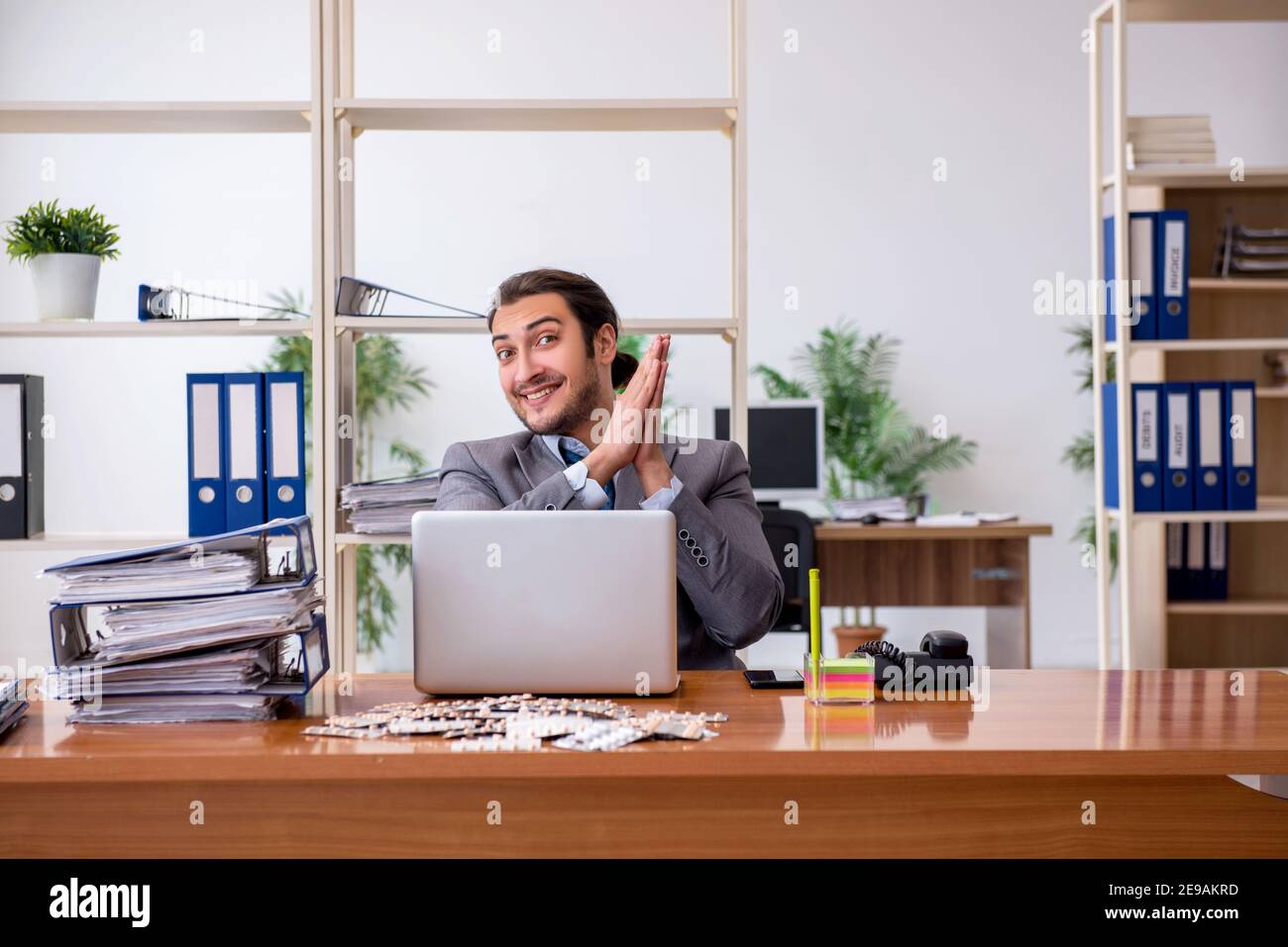 Male sick employee suffering at workplace Stock Photo - Alamy