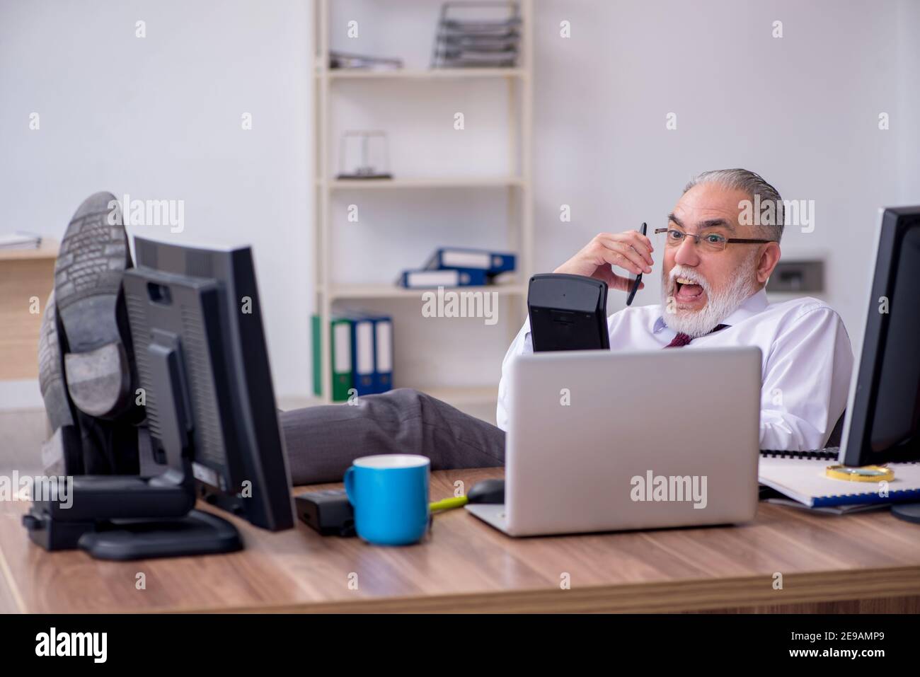 Old boss sitting desktop hi-res stock photography and images - Alamy
