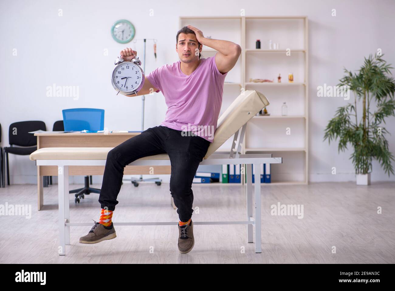 Male patient waiting for doctor in time management concept Stock Photo ...