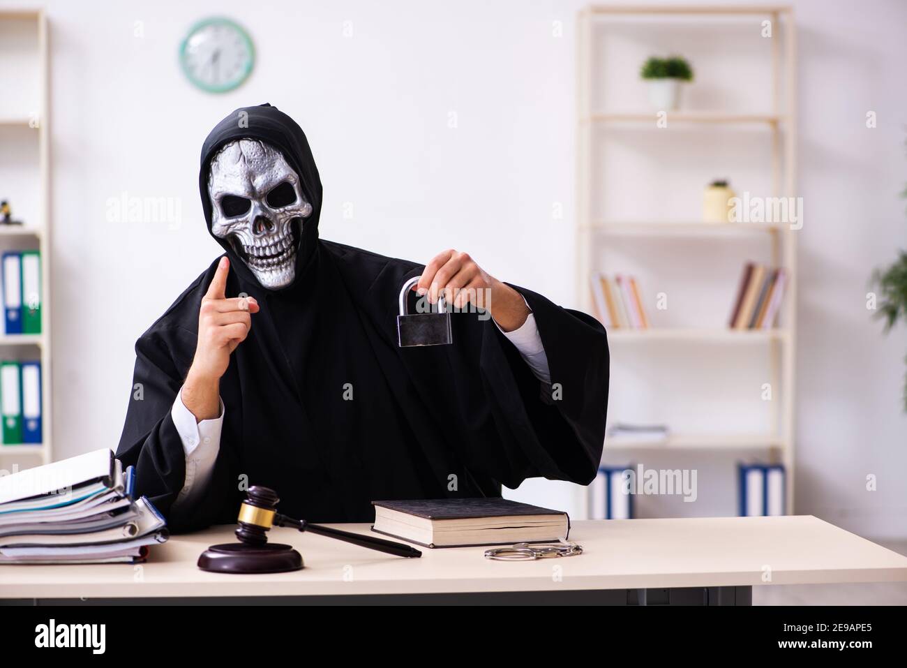 Devil judge working in the courthouse Stock Photo - Alamy