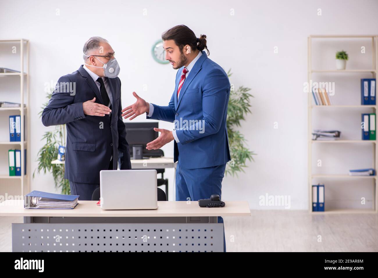 Employees at workplace during pandemic Stock Photo - Alamy