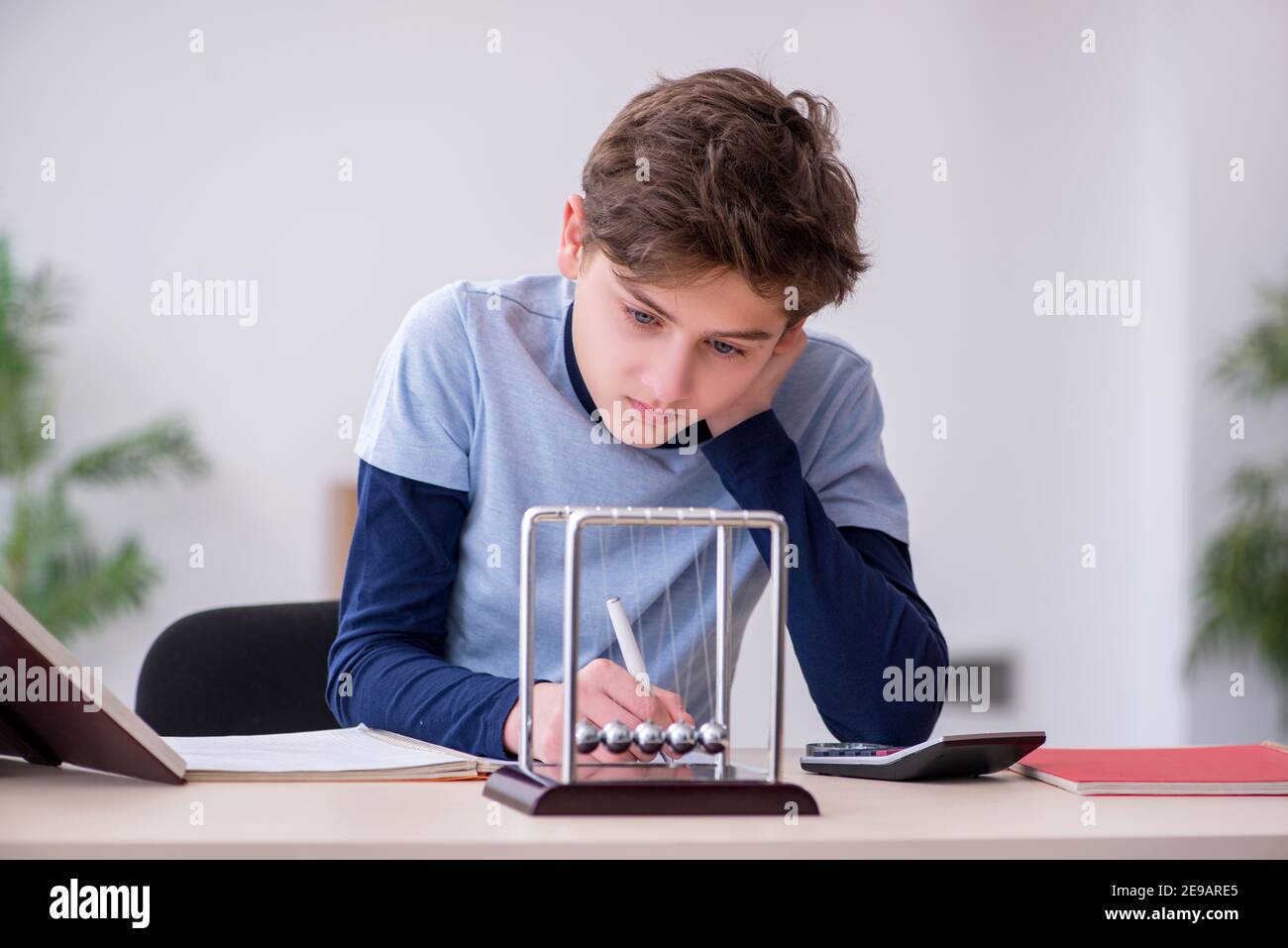 Boy studying physics at home Stock Photo - Alamy