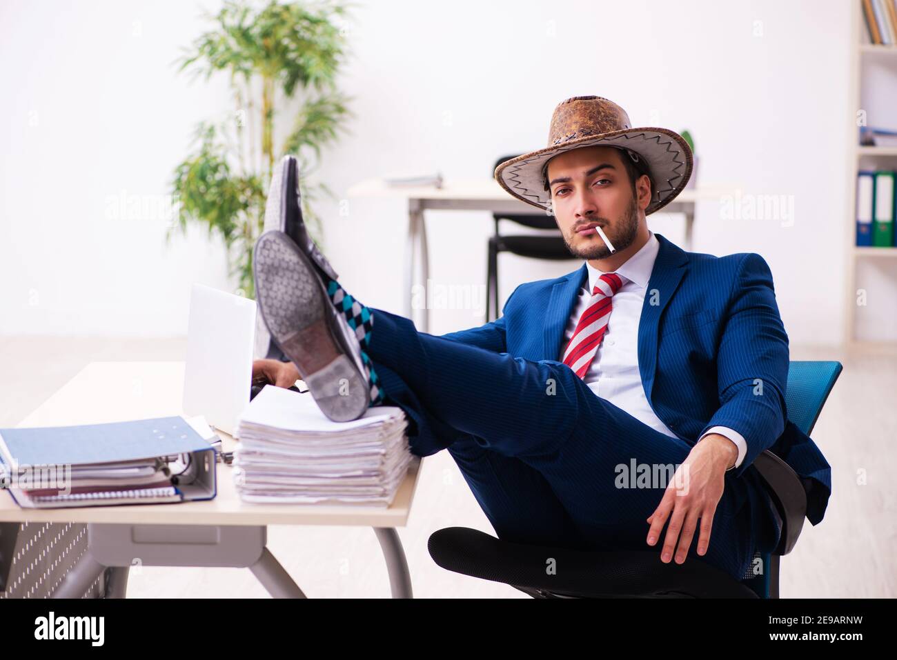 Young cowboy smoking cigarette hi-res stock photography and images - Alamy