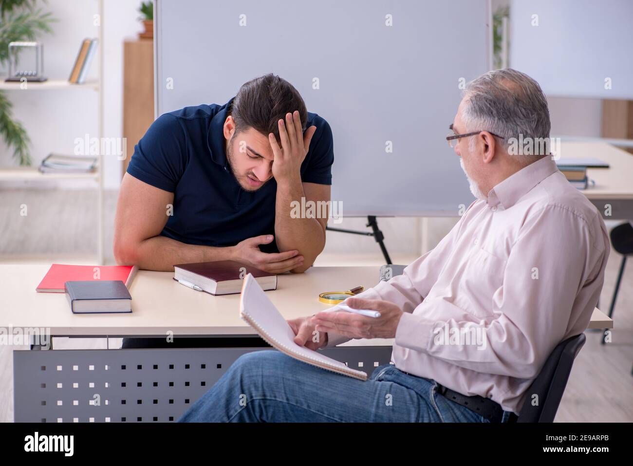 Old teacher and young student in the classroom Stock Photo - Alamy