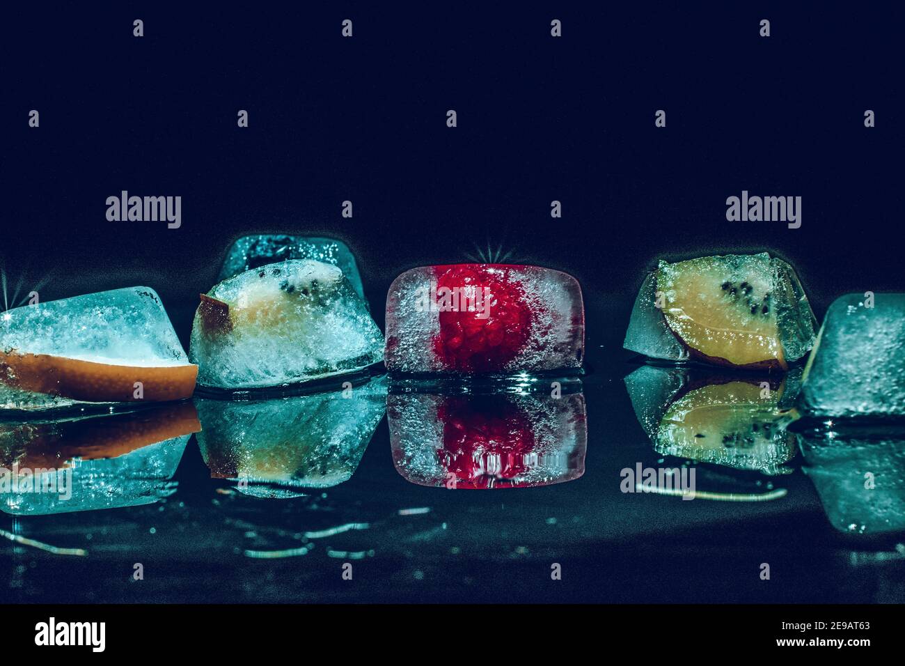 Fresh melting ice cubes with fruits on a dark background Stock Photo ...