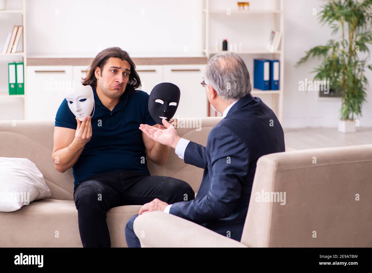 Man wearing masks during psychotherapy session Stock Photo - Alamy