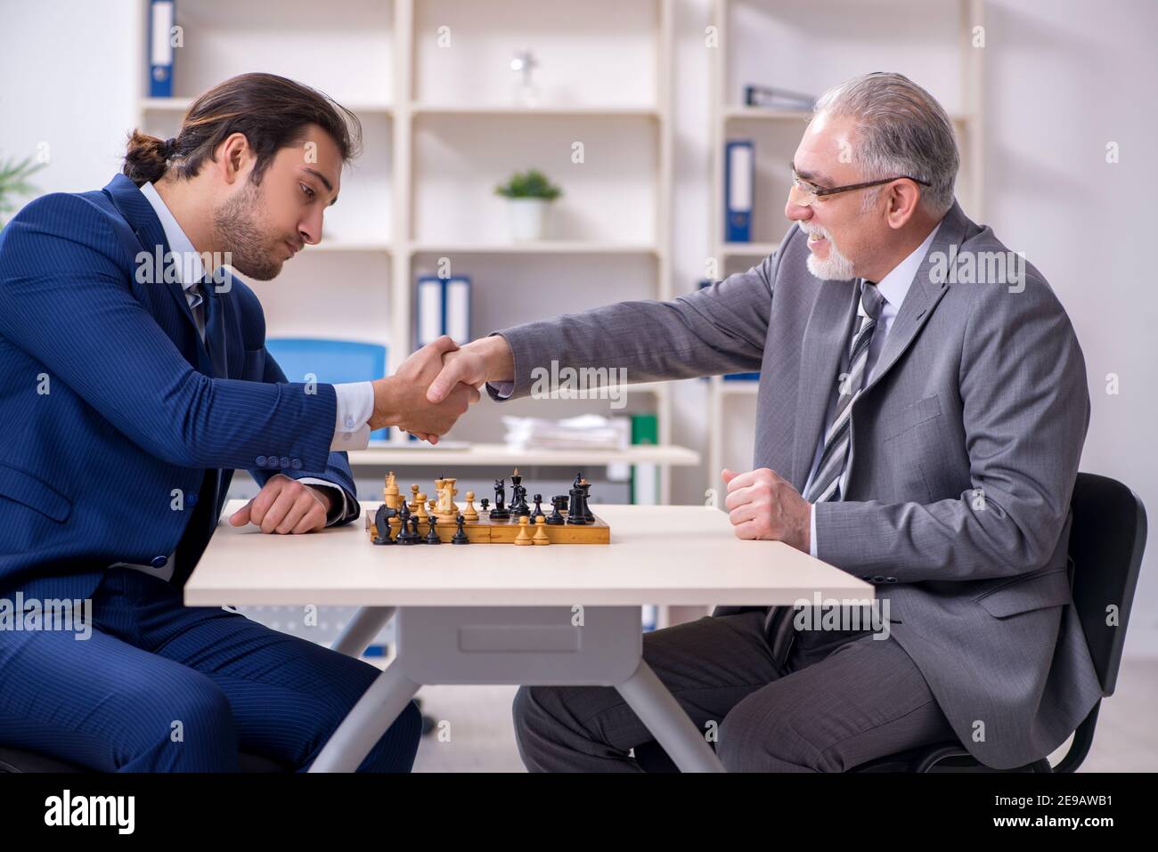 The two businessmen playing chess in the office Stock Photo - Alamy