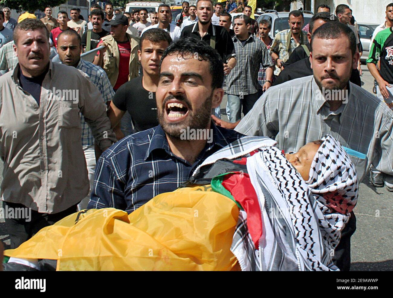 Palestinain men carry the body of eight-year-old Maher al-Mughrabi, who ...