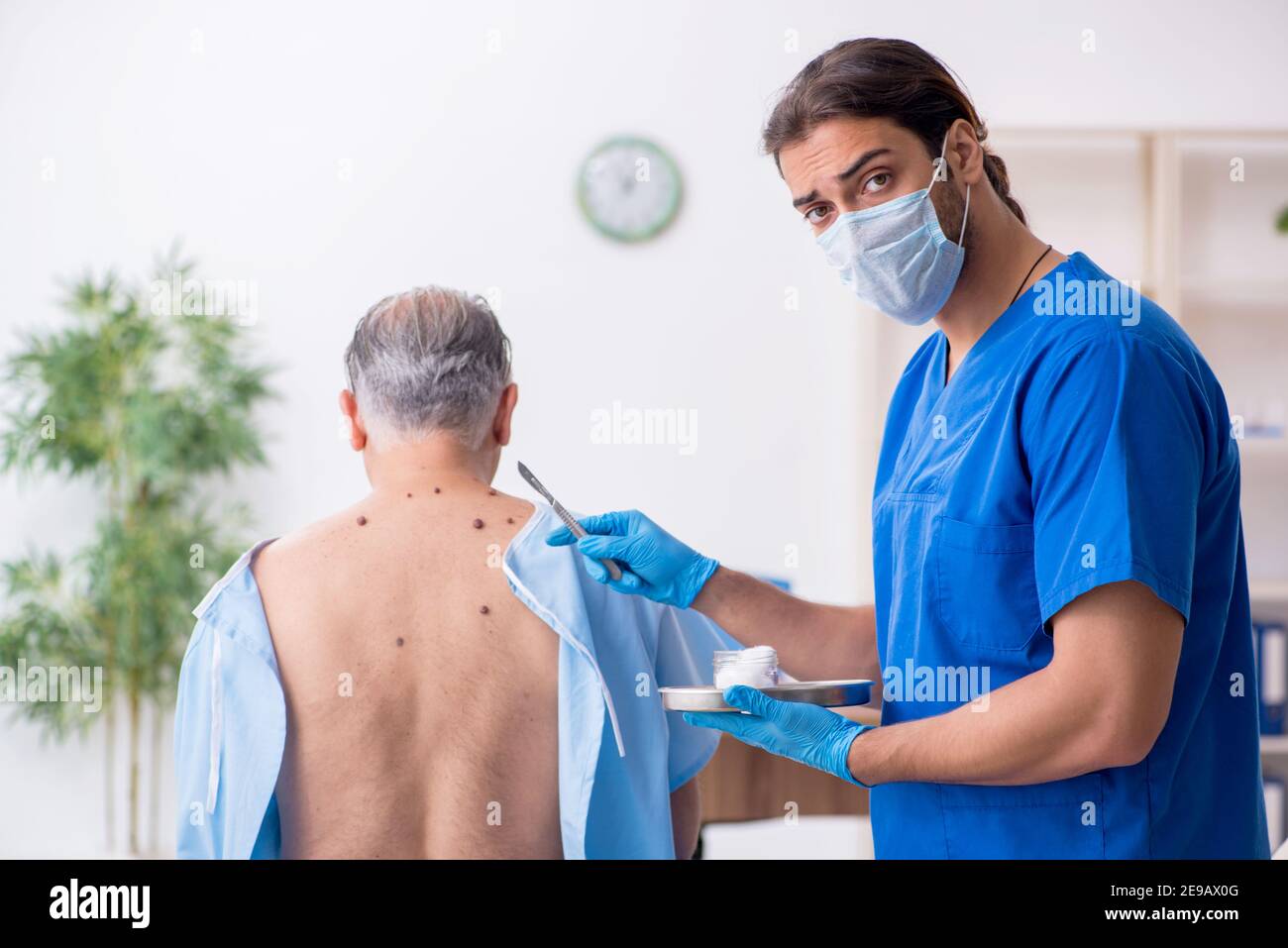 Old man visiting male doctor dermatologist Stock Photo - Alamy