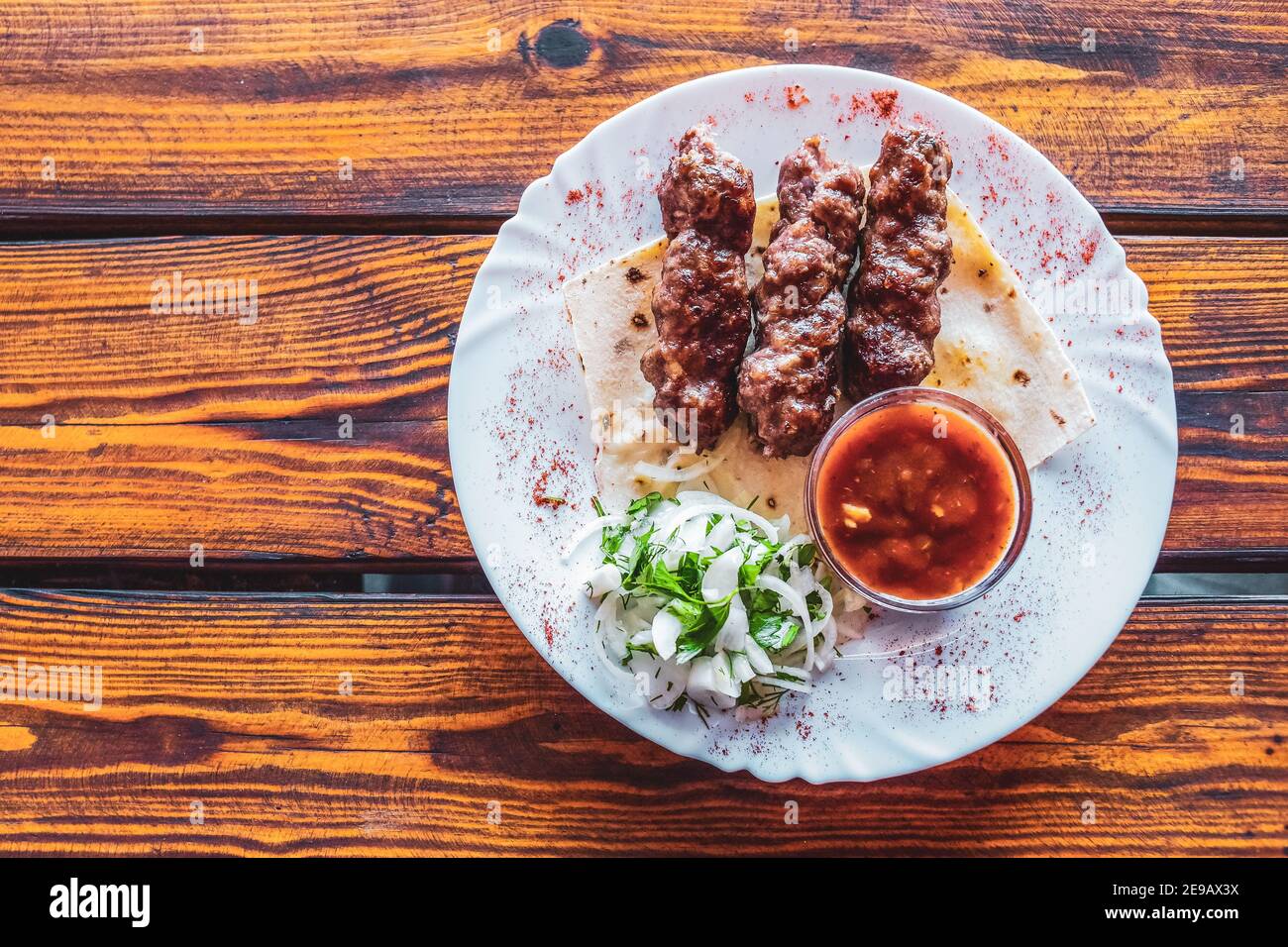 Portion luleh kebab on a plate. Appetizing dish on the wooden brown ...