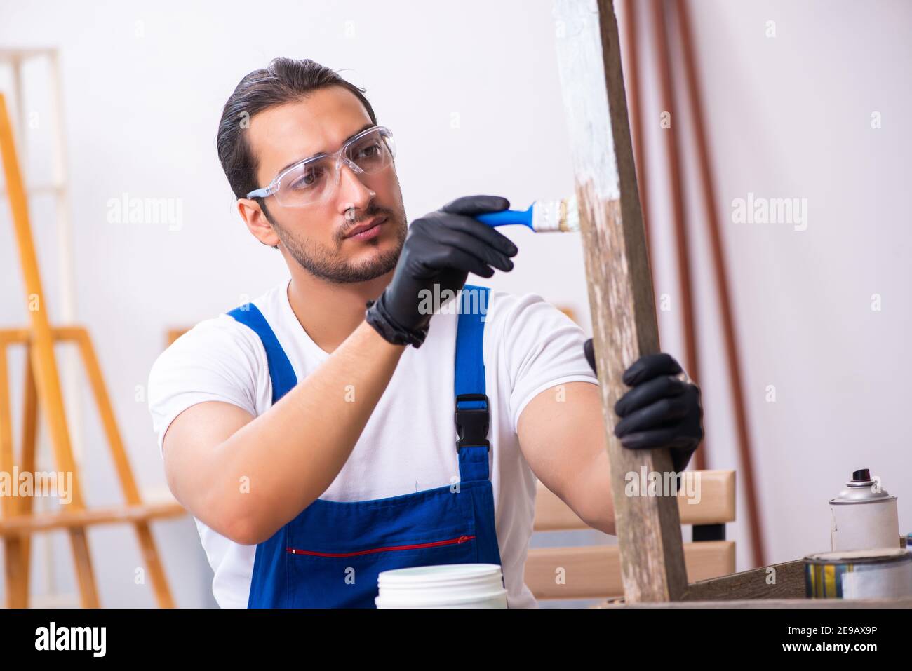 Young male contractor working in the workshop Stock Photo - Alamy