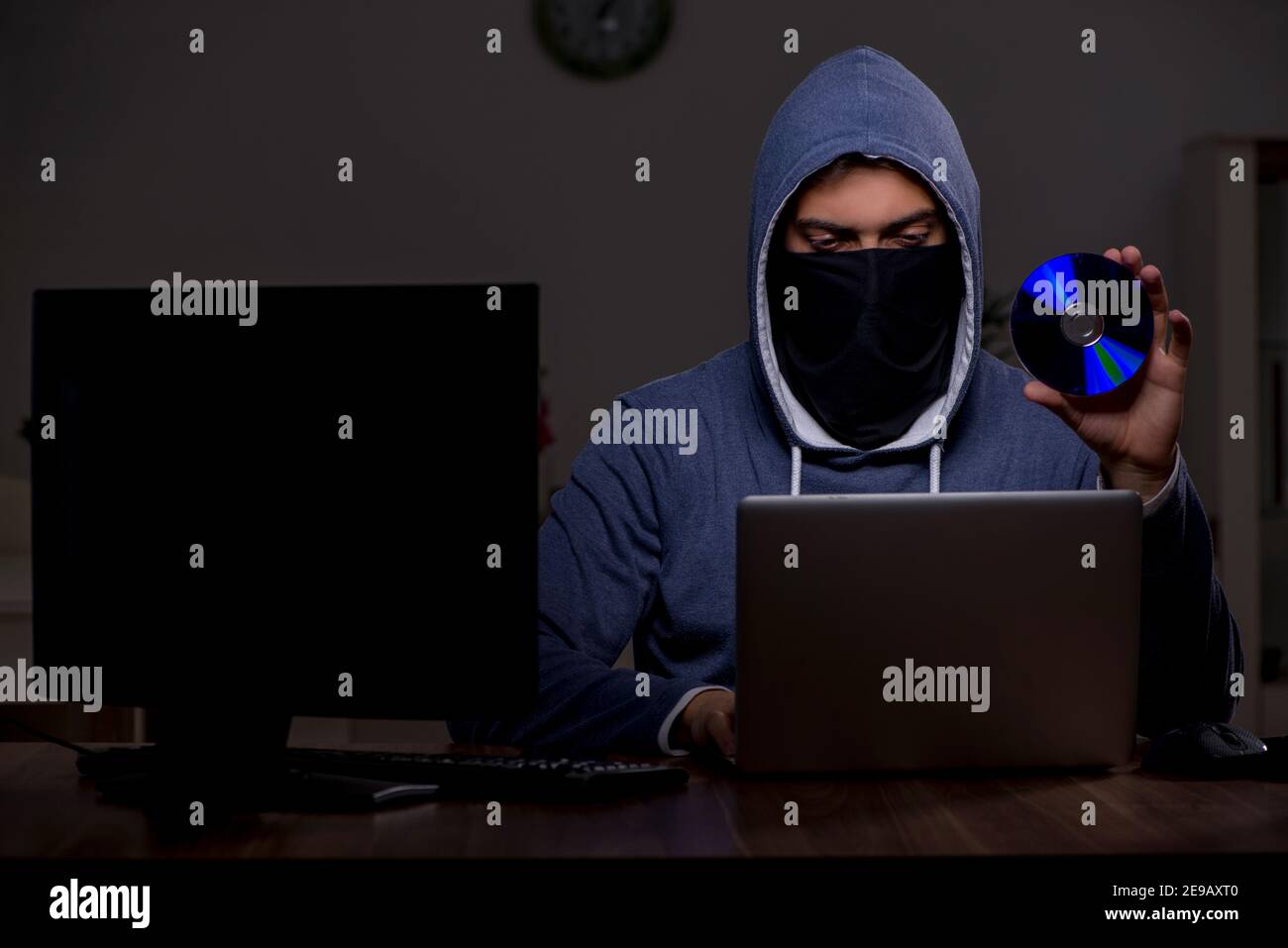 Male hacker hacking security firewall late in the office Stock Photo ...