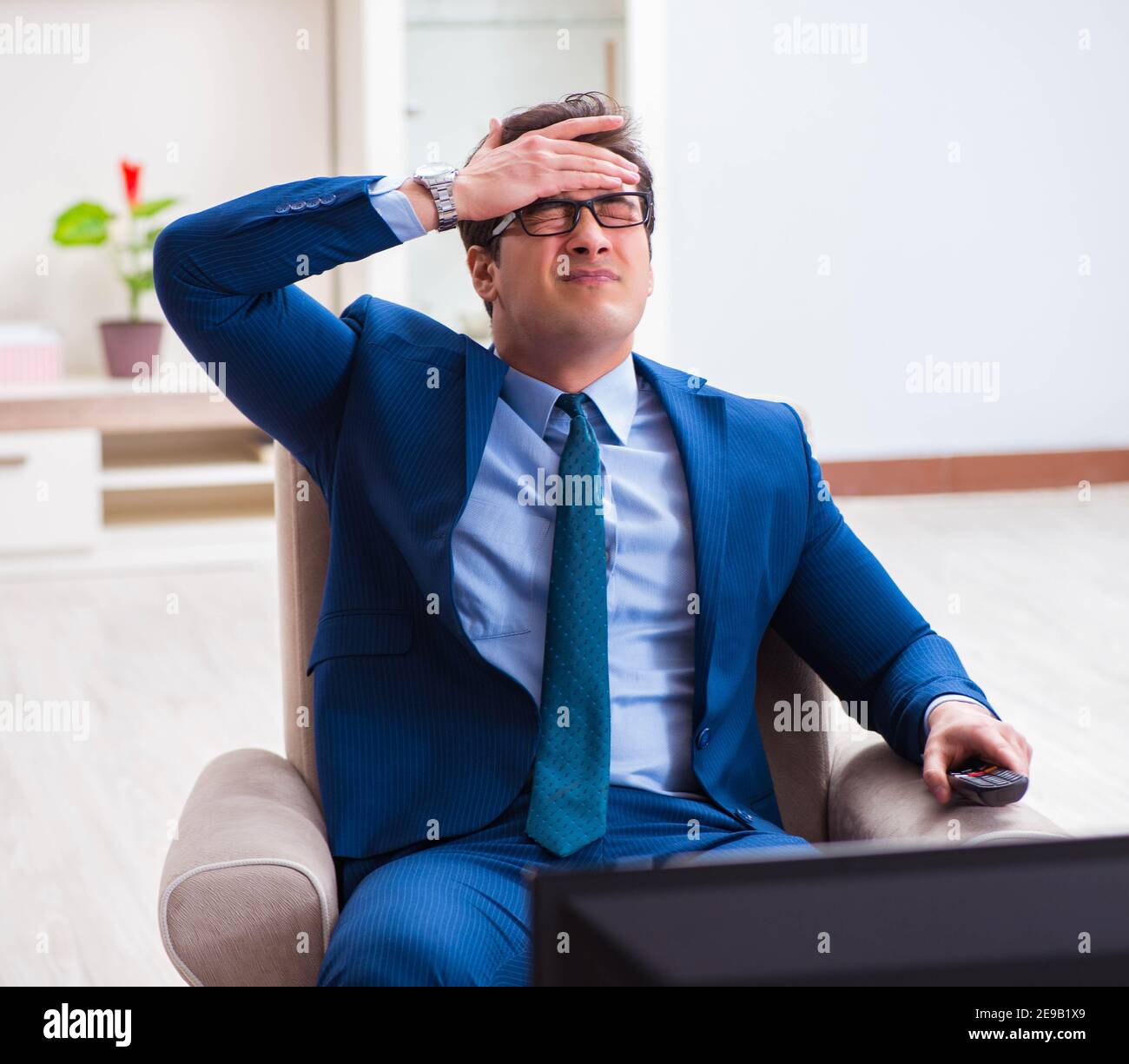 The businesman watching tv in office Stock Photo - Alamy