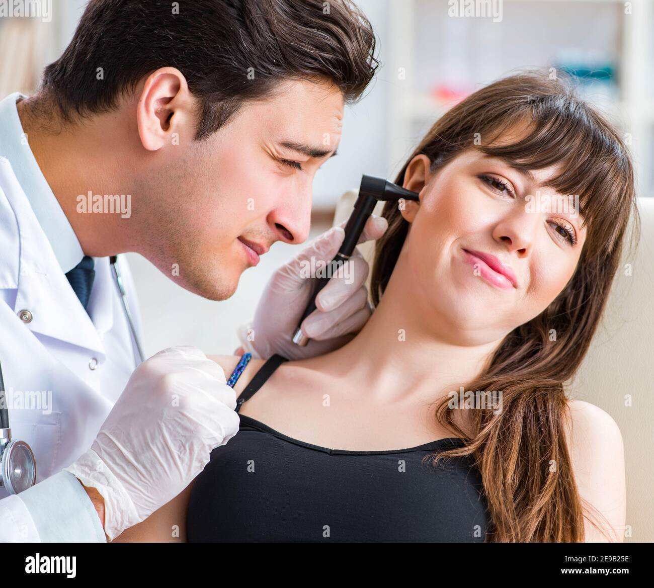 The doctor checking patients ear during medical examination Stock Photo ...