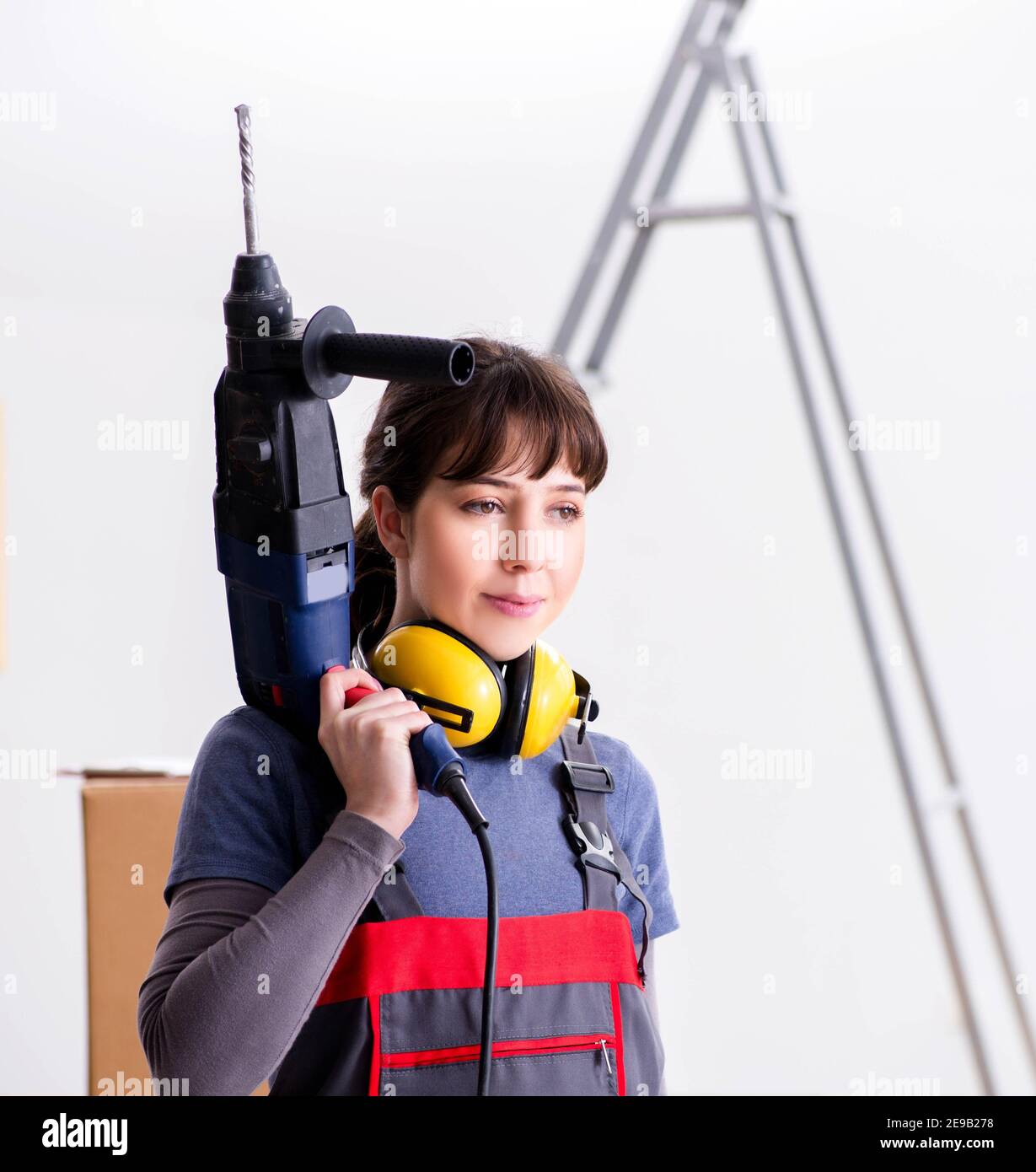 The woman contractor with hand drill at construction site Stock Photo ...