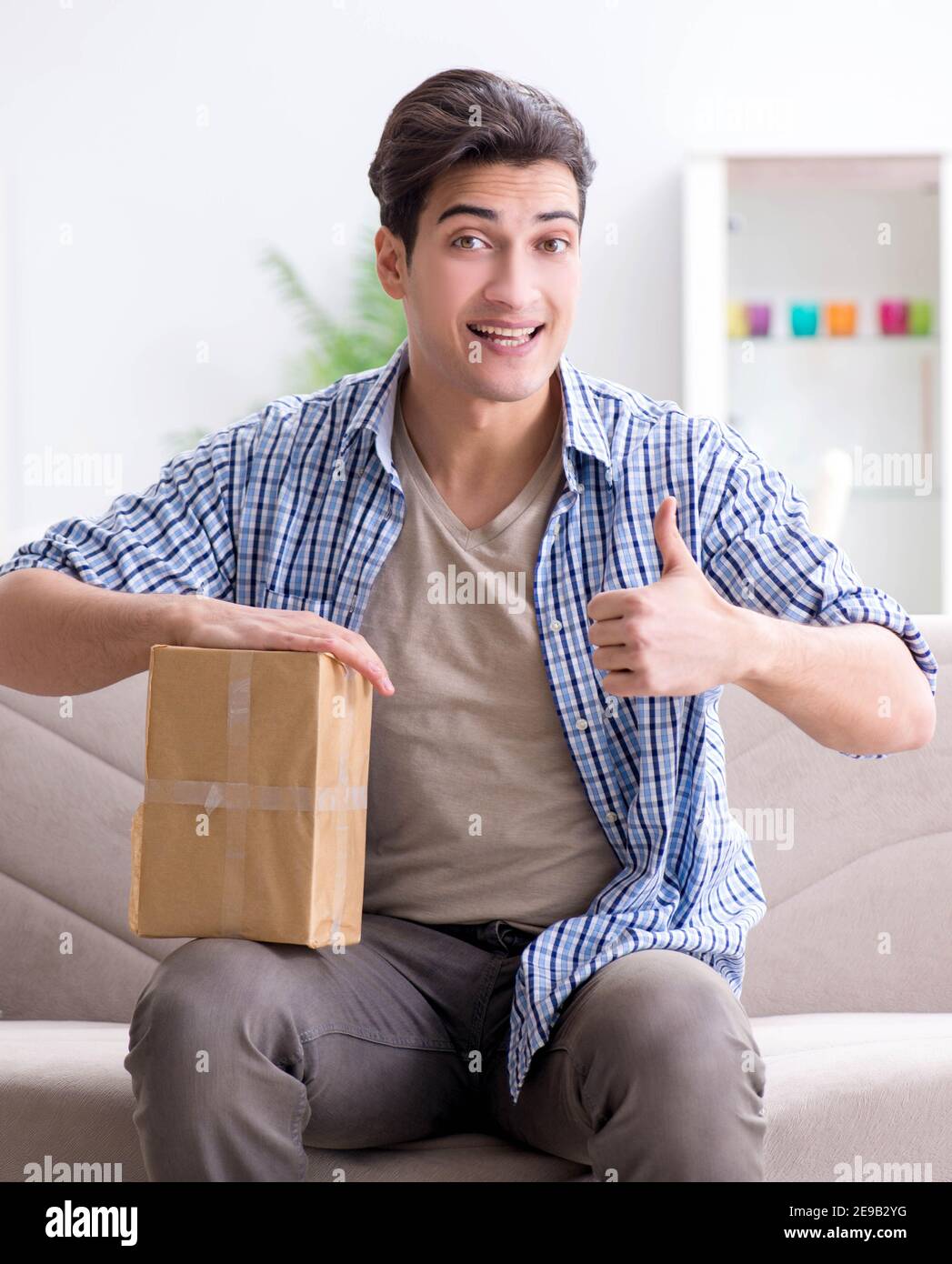 The man receiving parcel at home Stock Photo - Alamy