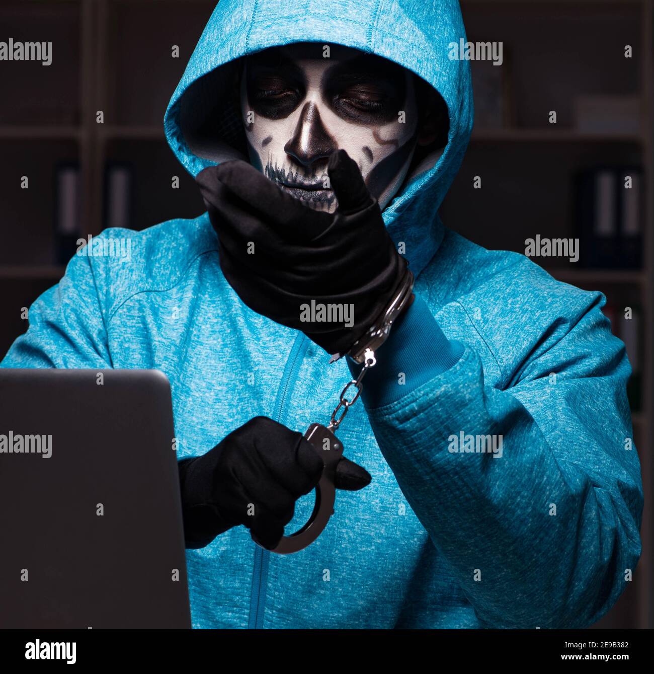 The scary hacker hacking security firewall late in office Stock Photo ...