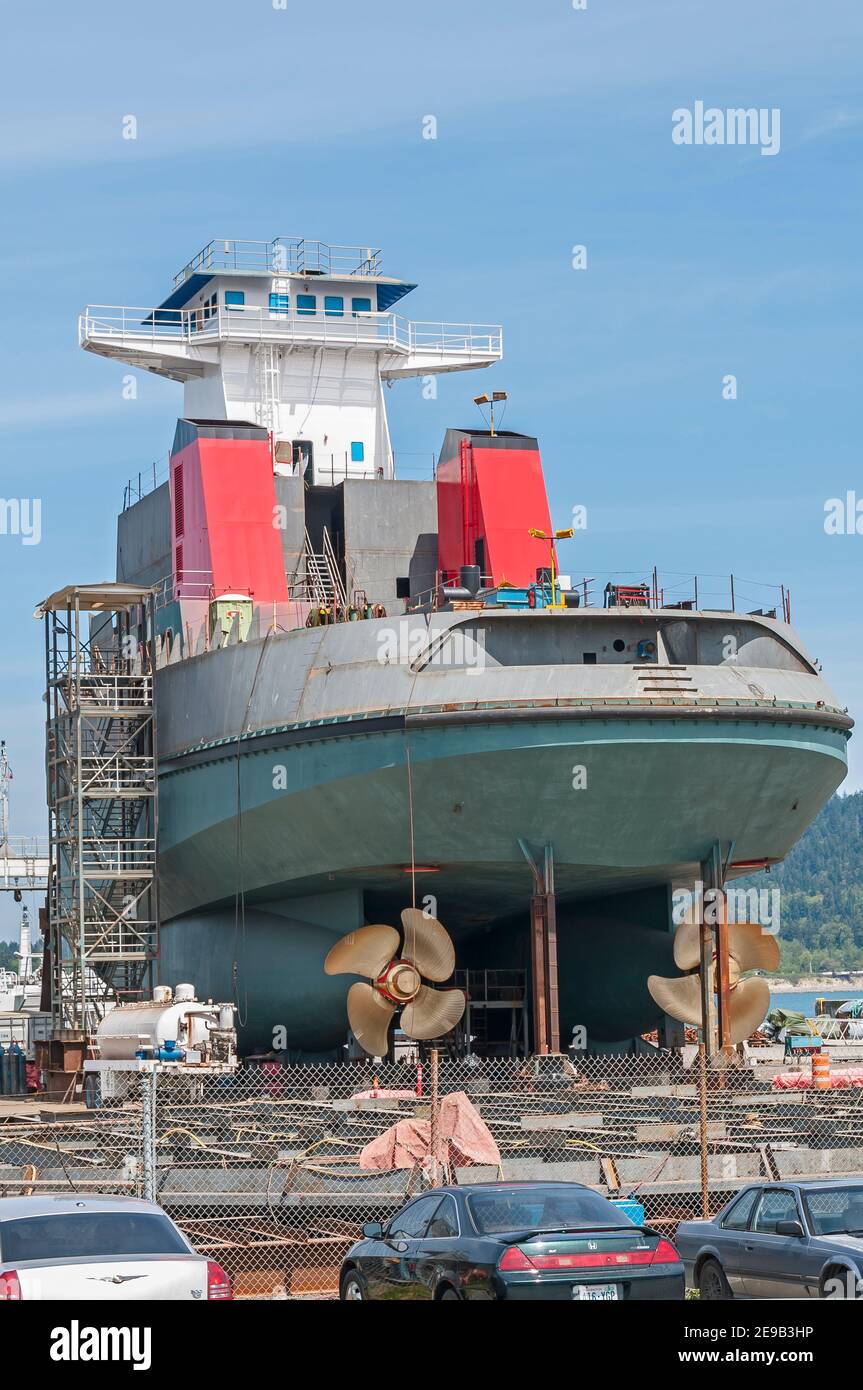 The stern of a large ship in drydock, showing the propellers (screws ...