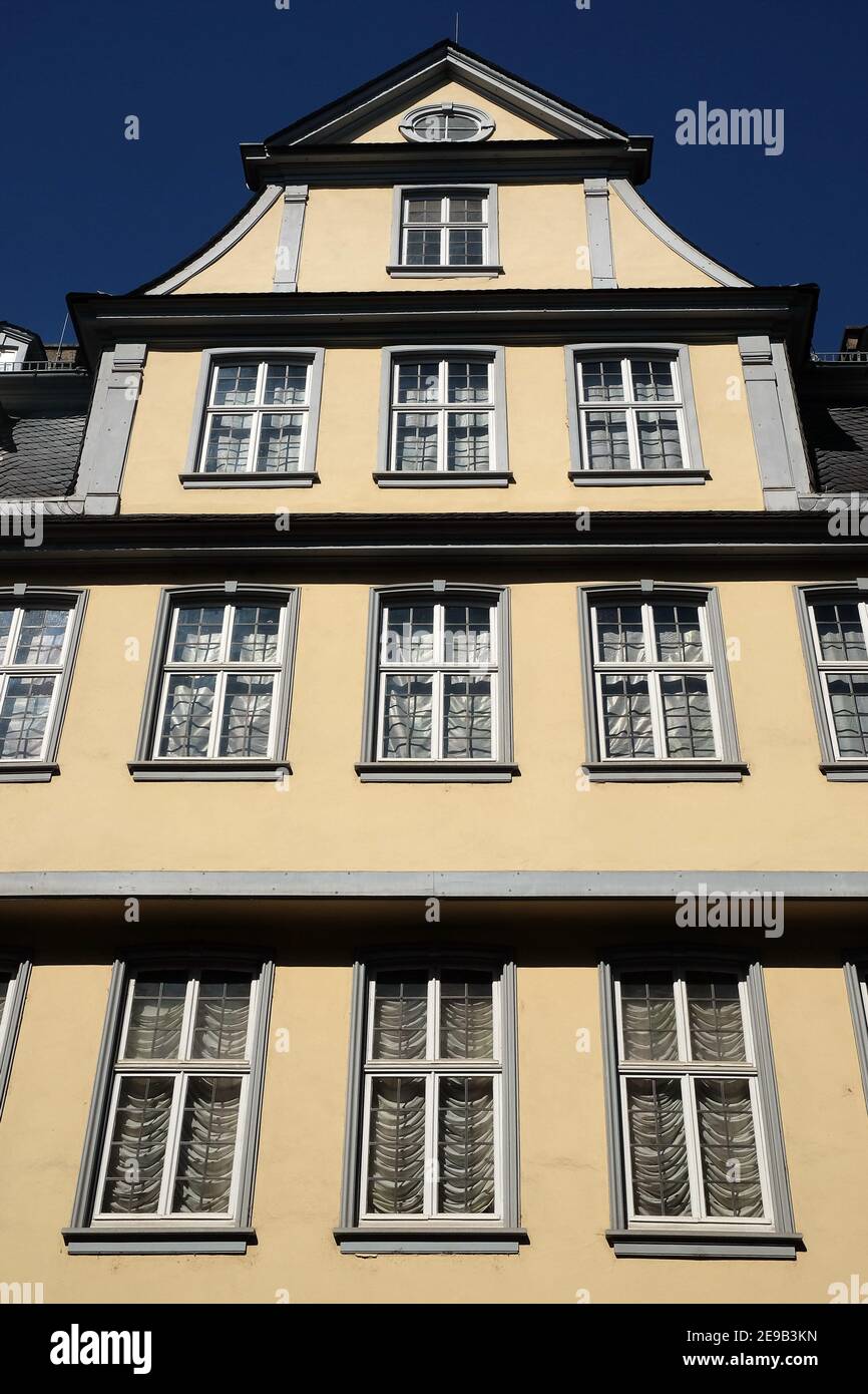 Vertical low angle of a modern residential building under a blue sky background Stock Photo - Alamy
