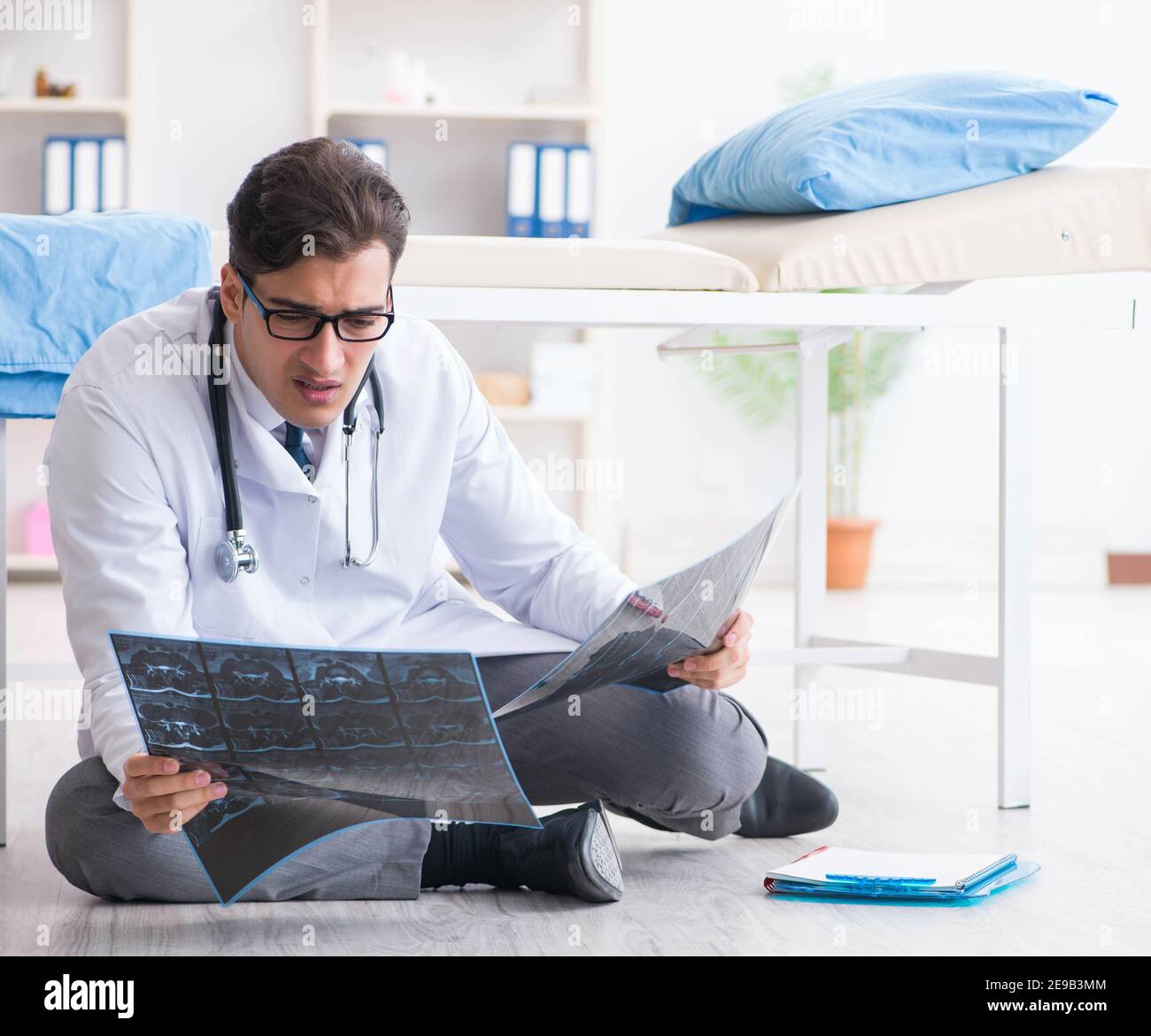 The doctor sitting on the floor in hospital Stock Photo - Alamy
