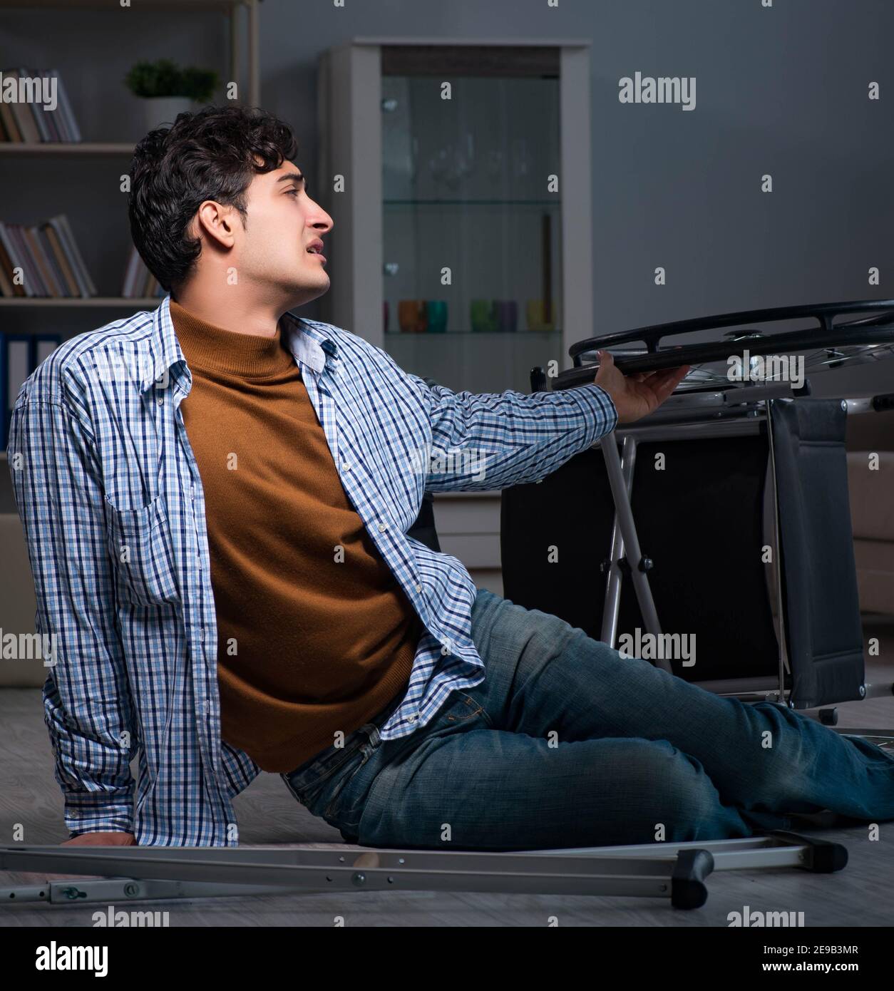 The man fell off wheelchair sitting on the floor Stock Photo - Alamy