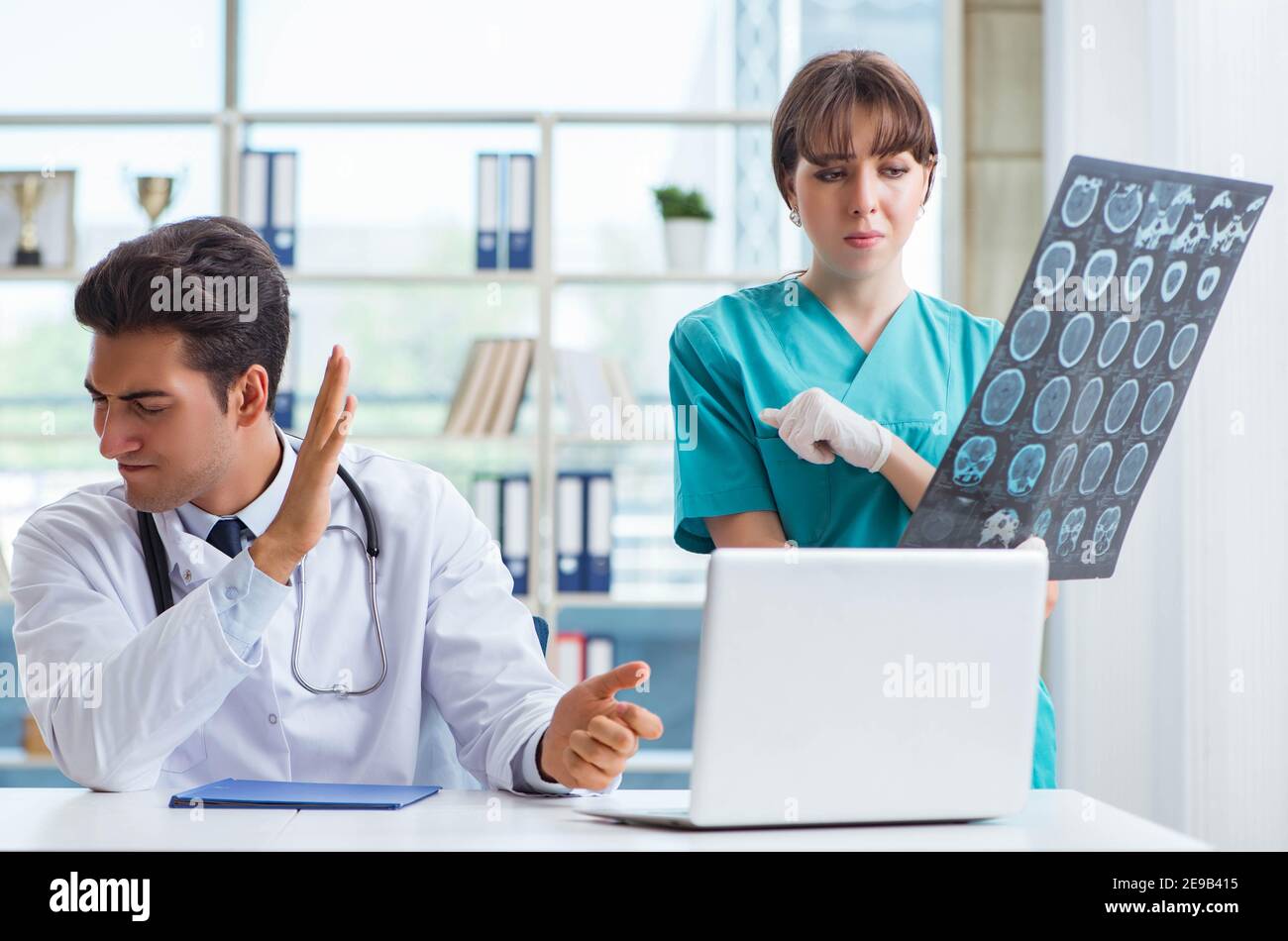 The two doctors discussing x-ray mri image in hospital Stock Photo - Alamy