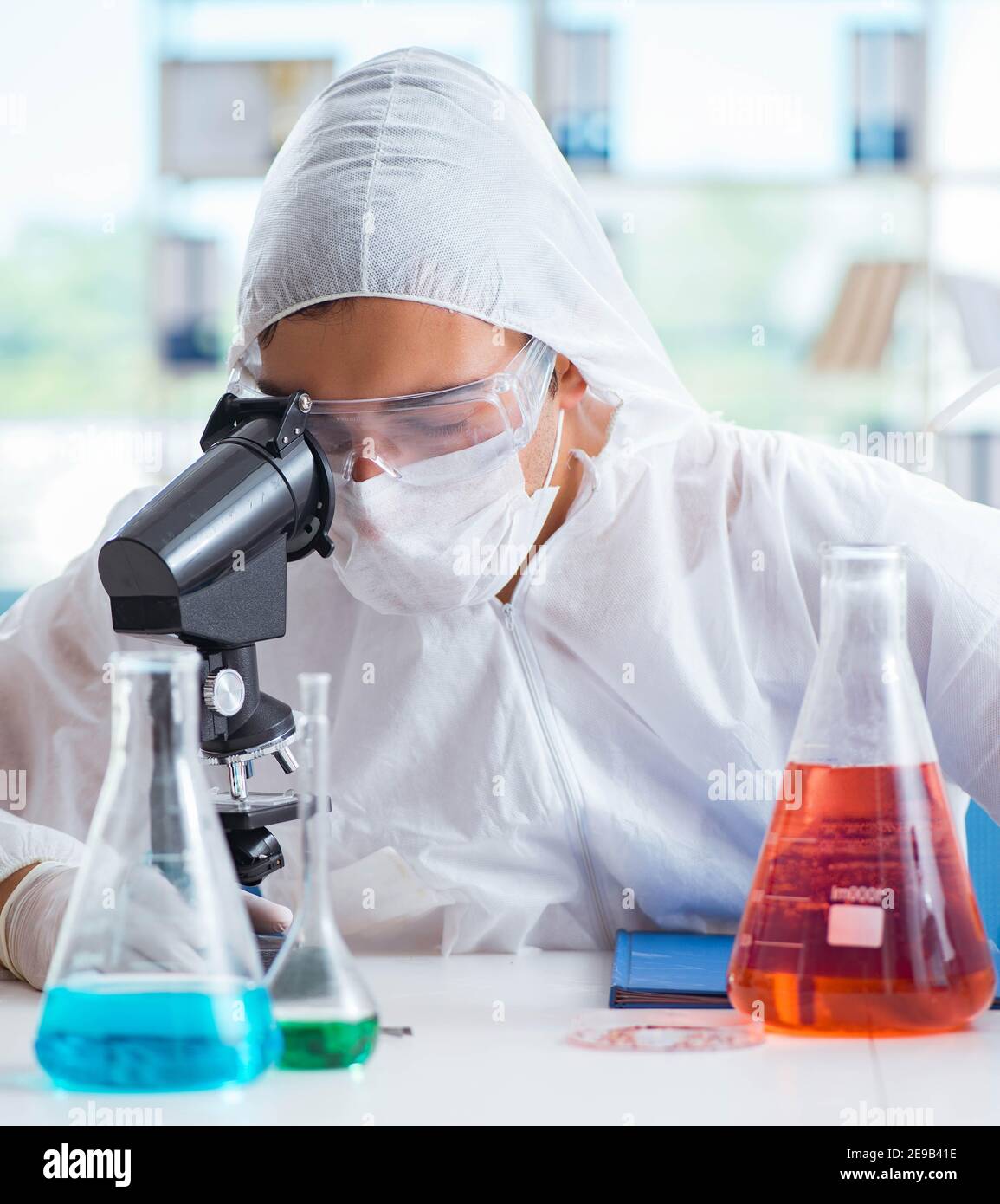 The chemist working in the laboratory with hazardous chemicals Stock ...
