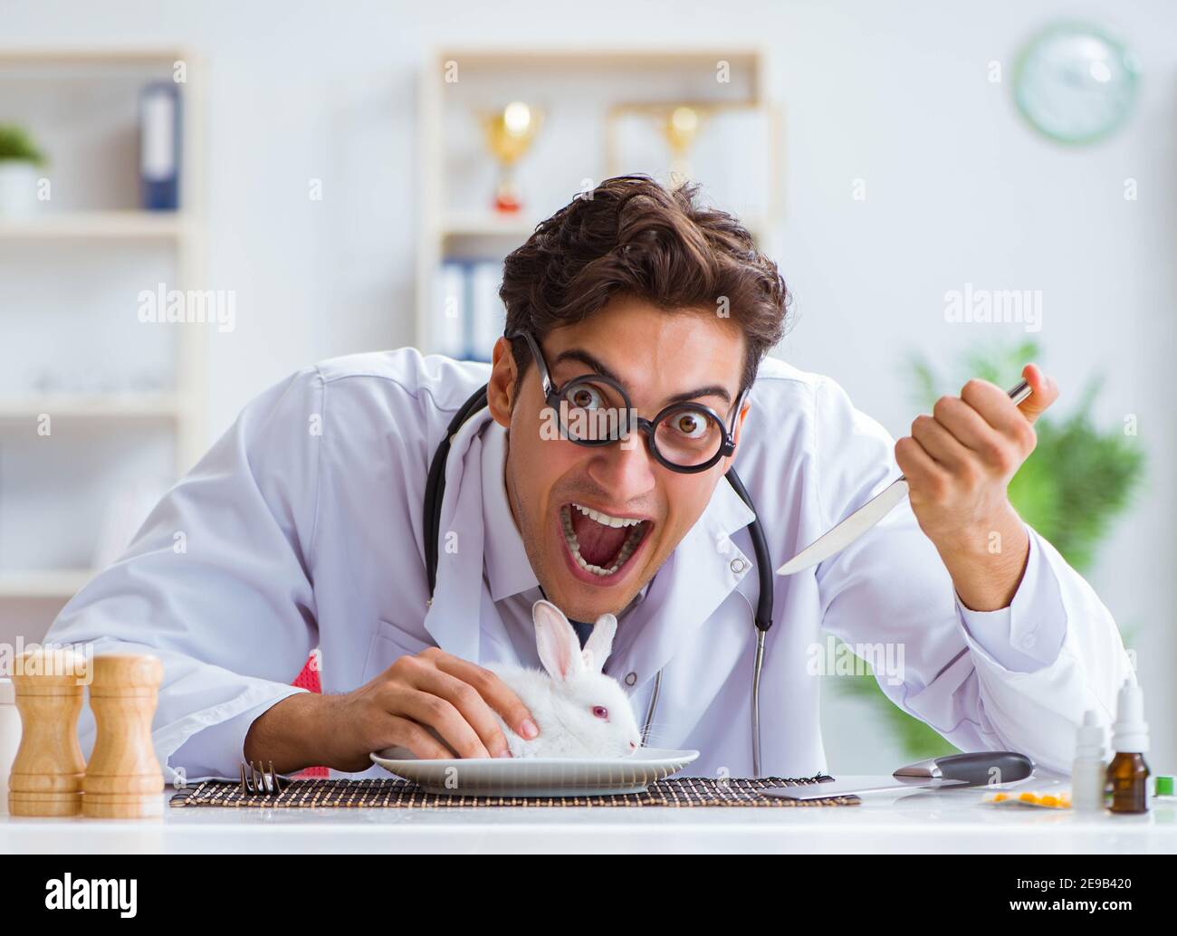 The mad crazy doctor preparing to eat rabbit Stock Photo - Alamy