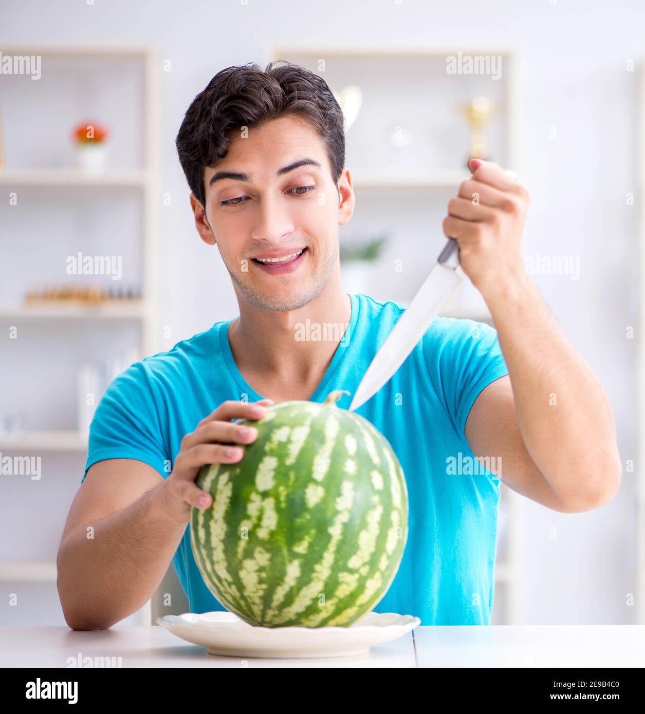 The man eating watermelon at home Stock Photo - Alamy