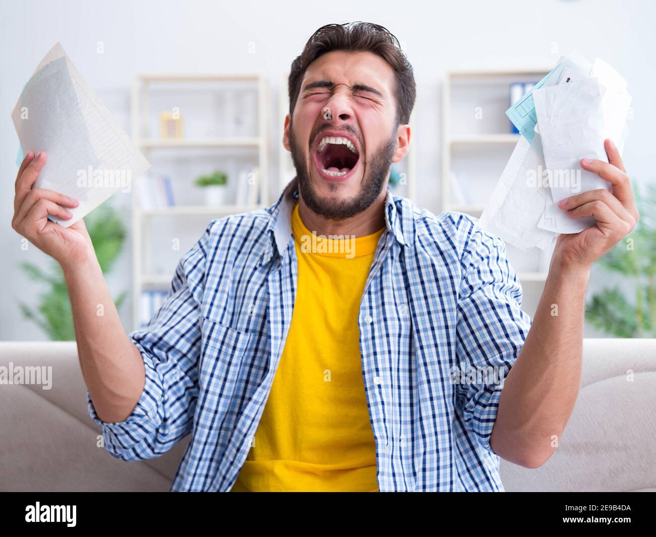 The man angry at bills he needs to pay Stock Photo - Alamy