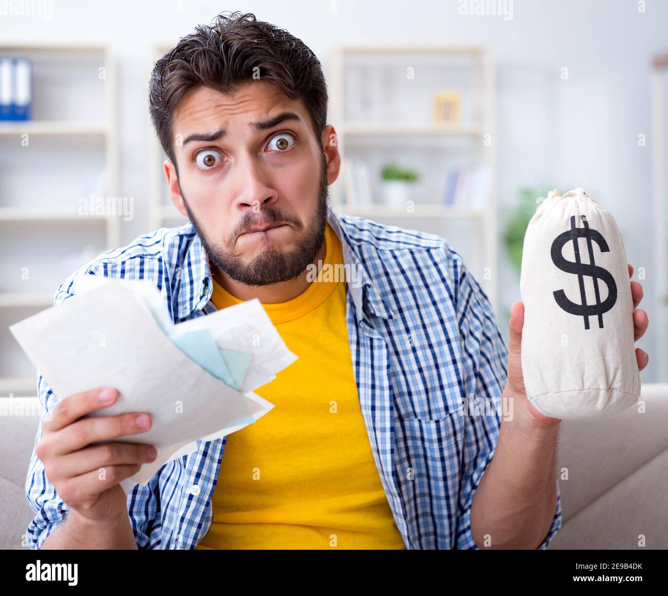 The man angry at bills he needs to pay Stock Photo - Alamy